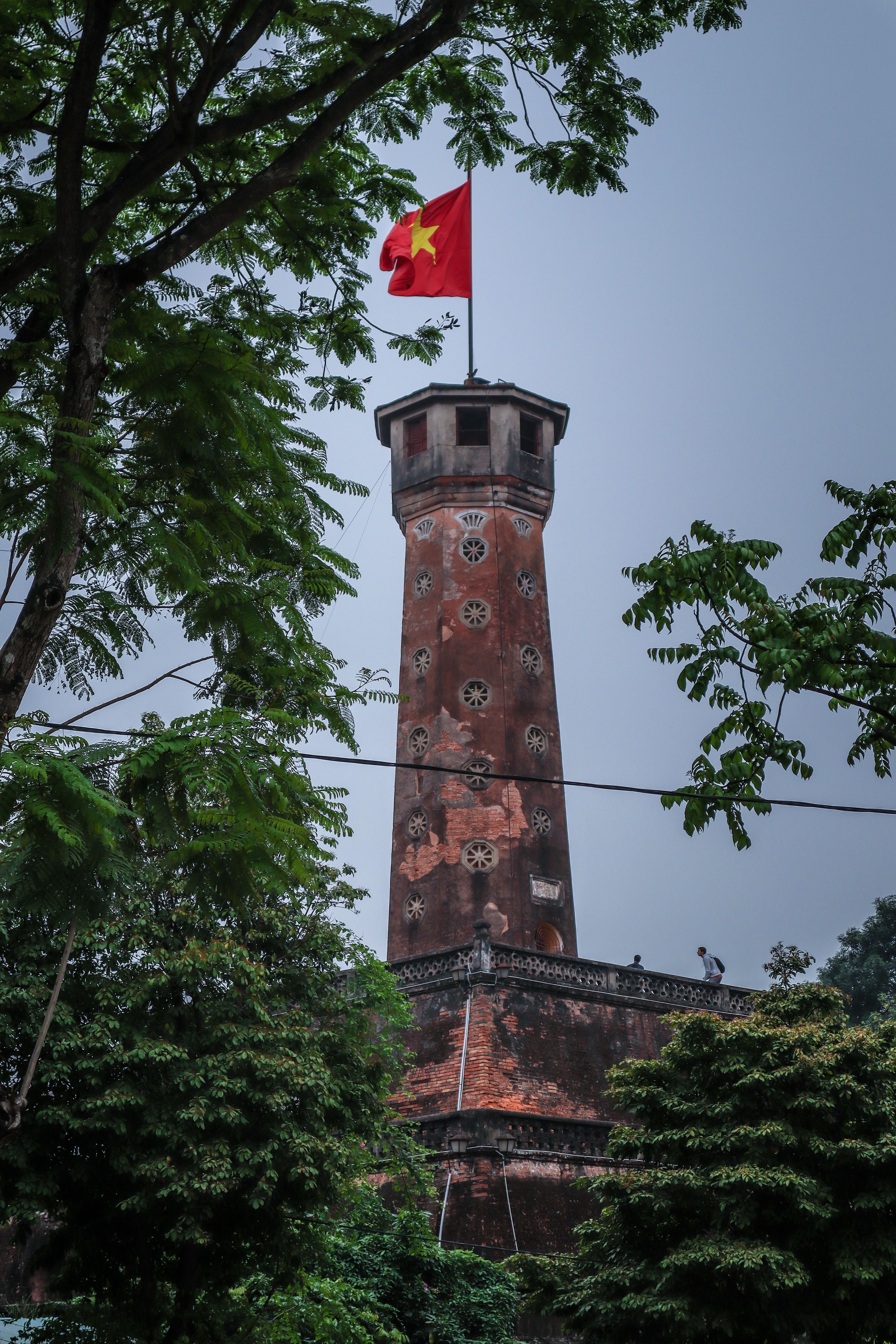 Iconic Hanoi Flag Tower with Vietnamese Flag · Free Stock Photo