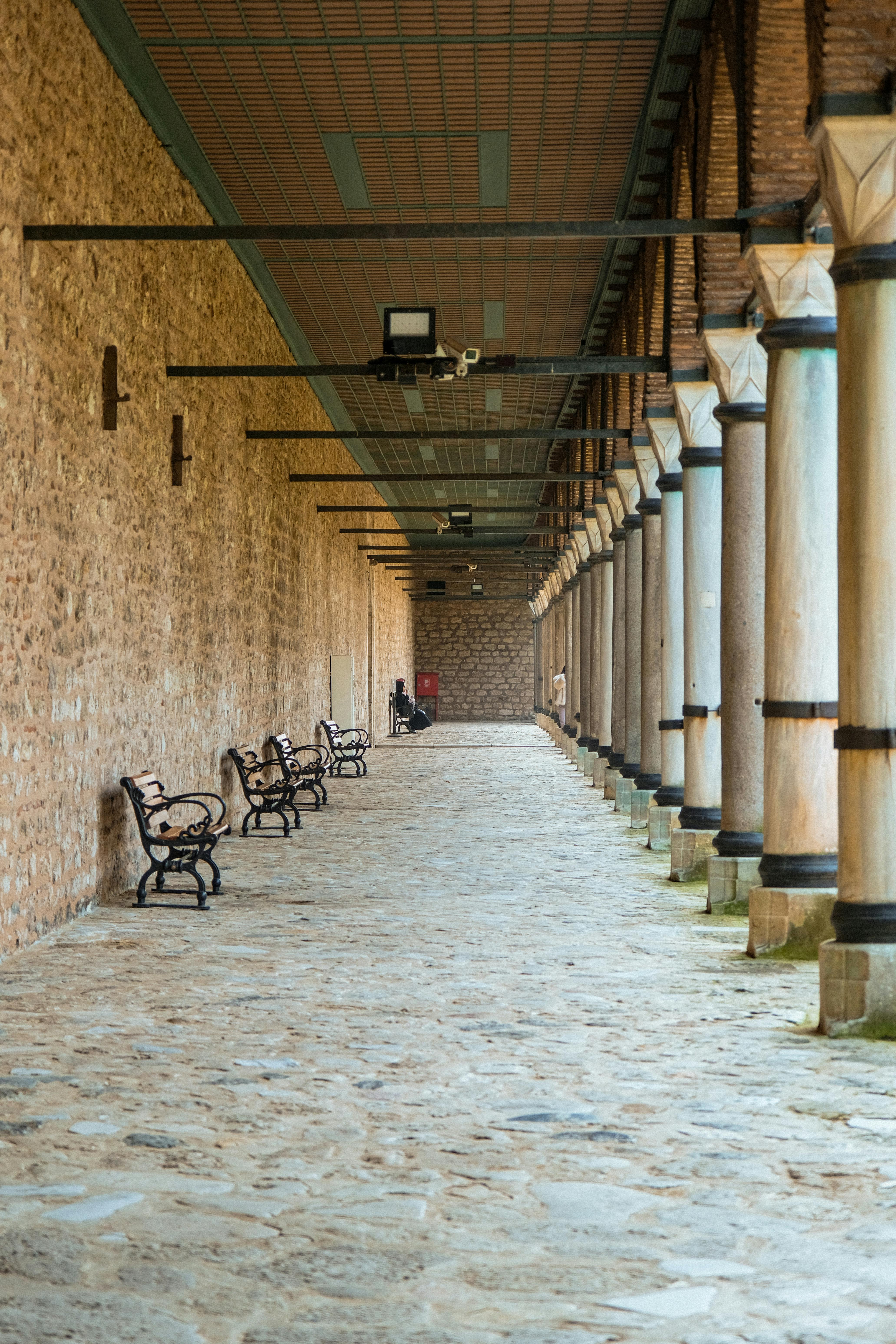 Historic Architectural Hallway with Stone Columns · Free Stock Photo