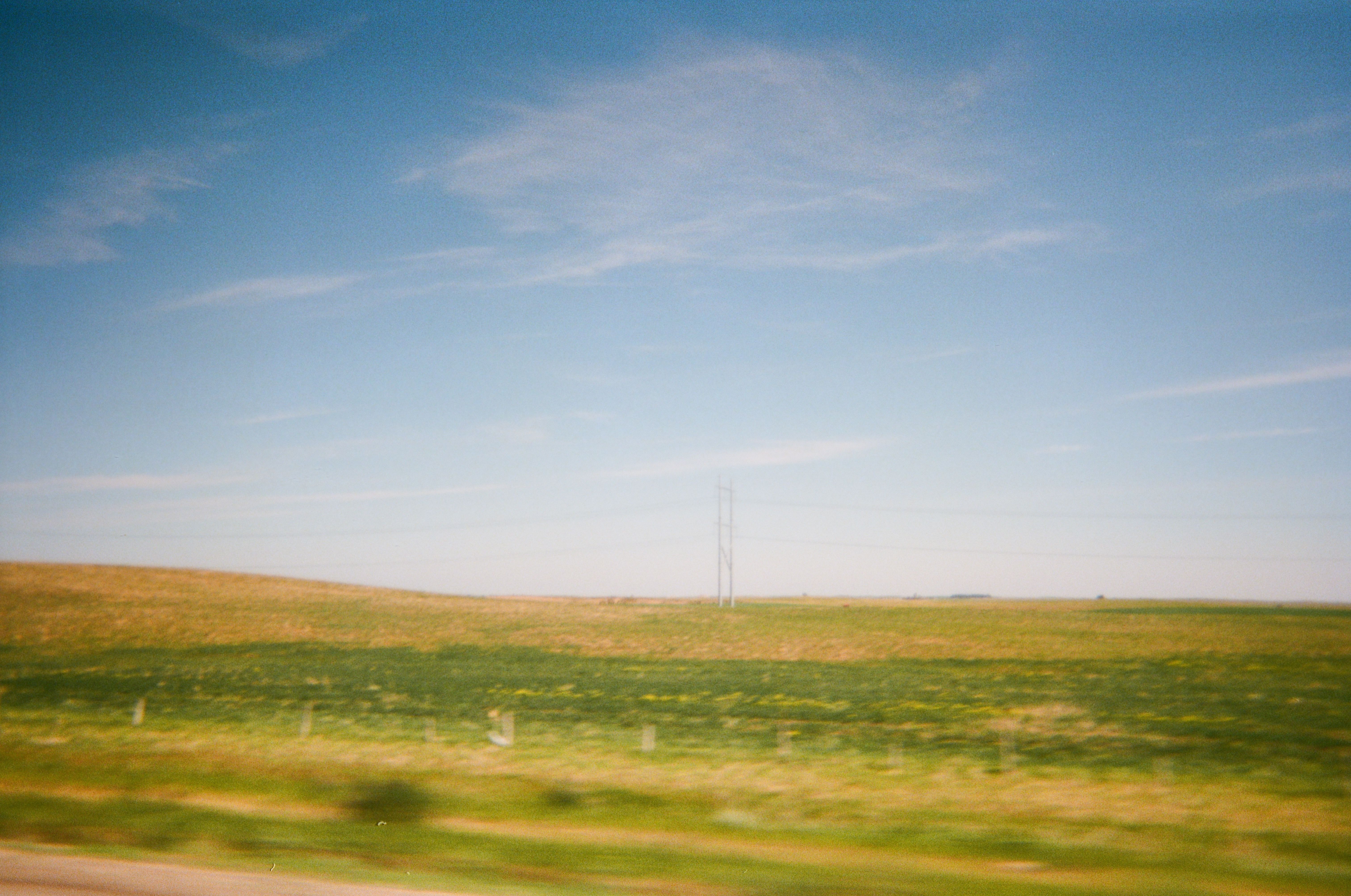 Vast Open Field Under Clear Blue Sky · Free Stock Photo