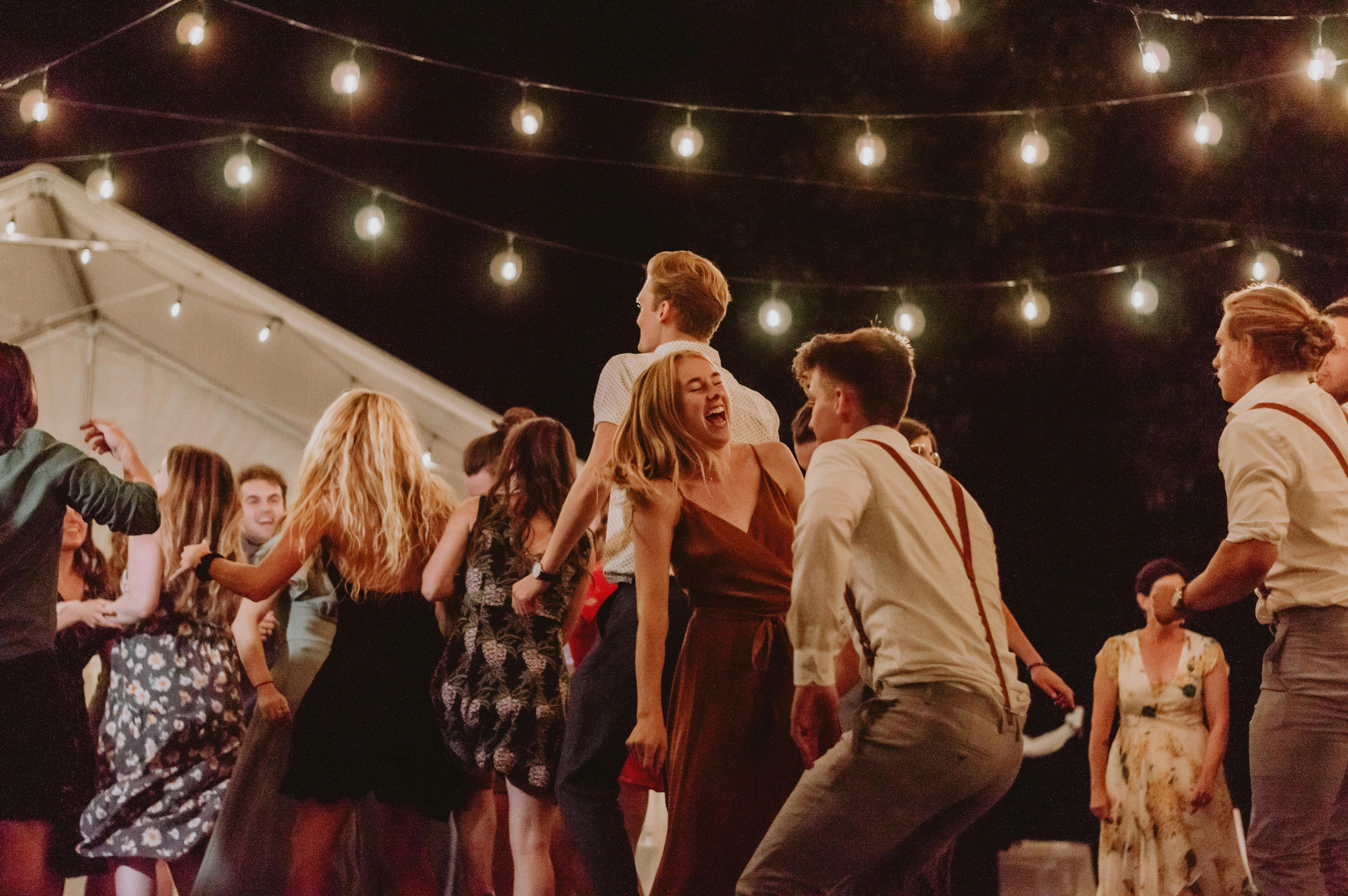 Joyful Outdoor Night Party with String Lights · Free Stock Photo