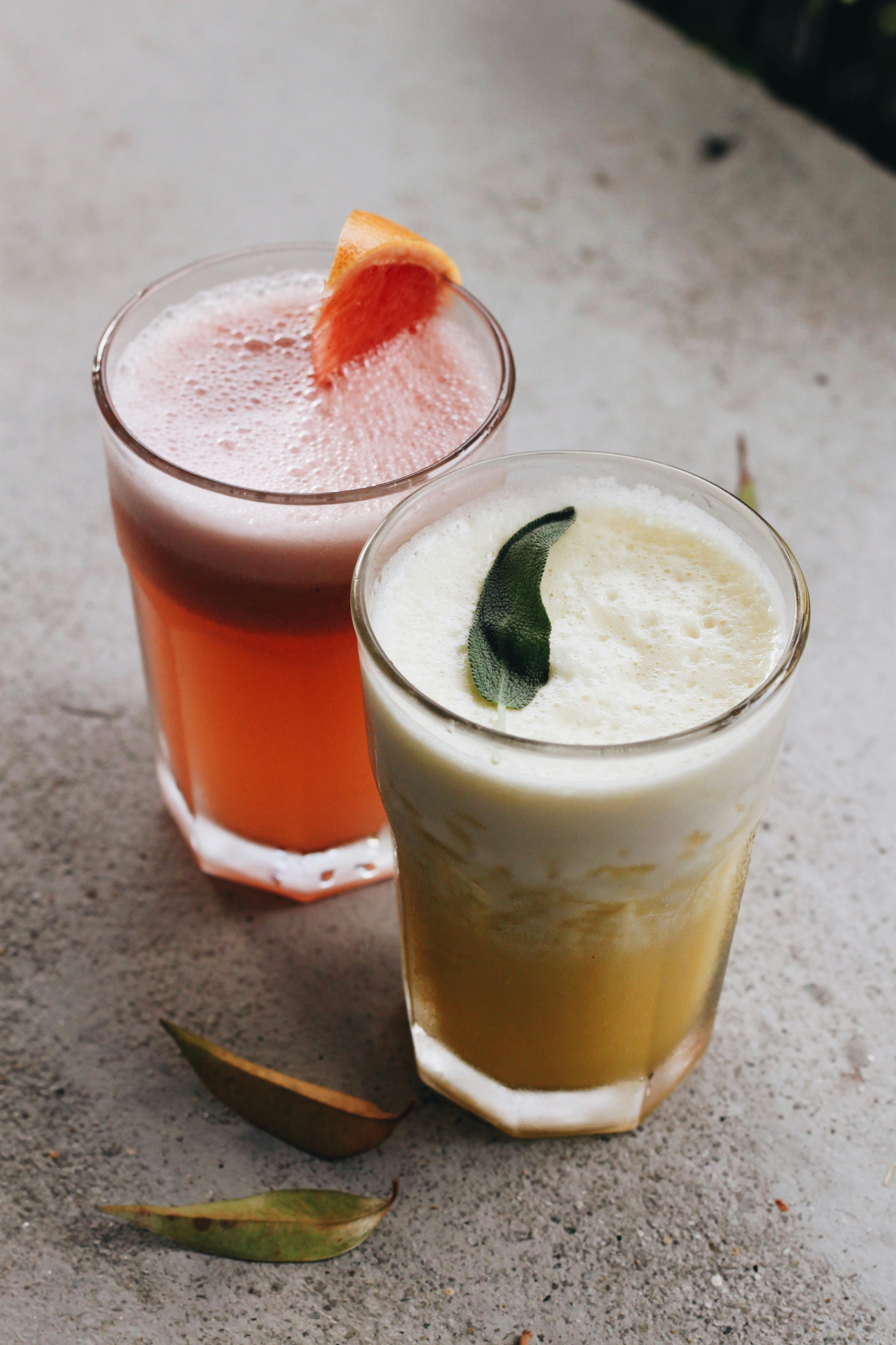 Refreshing Citrus and Tropical Drinks on a Table · Free Stock Photo