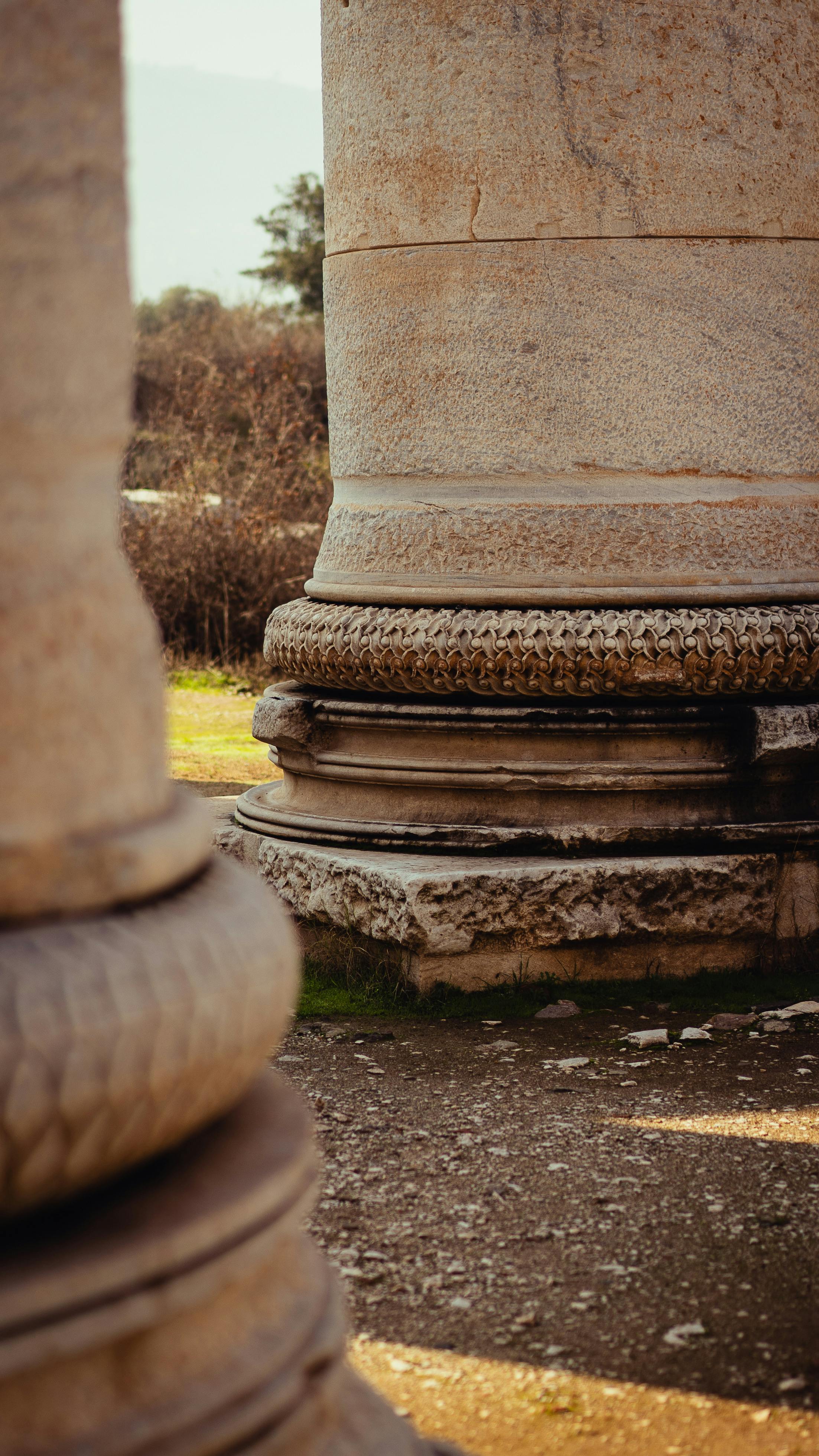 Ancient Weathered Stone Columns in Outdoor Setting · Free Stock Photo