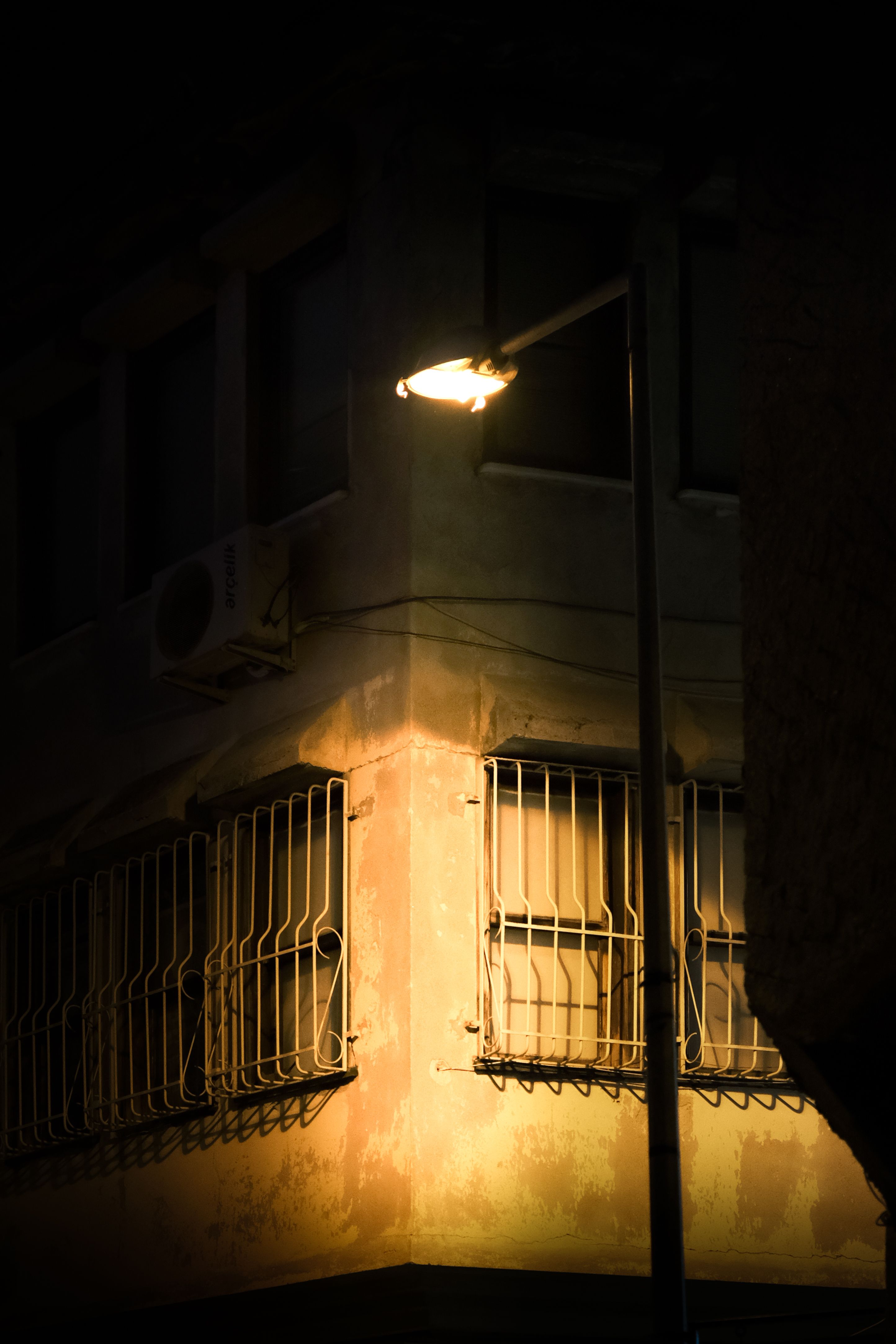 Streetlamp illuminating urban building corner · Free Stock Photo