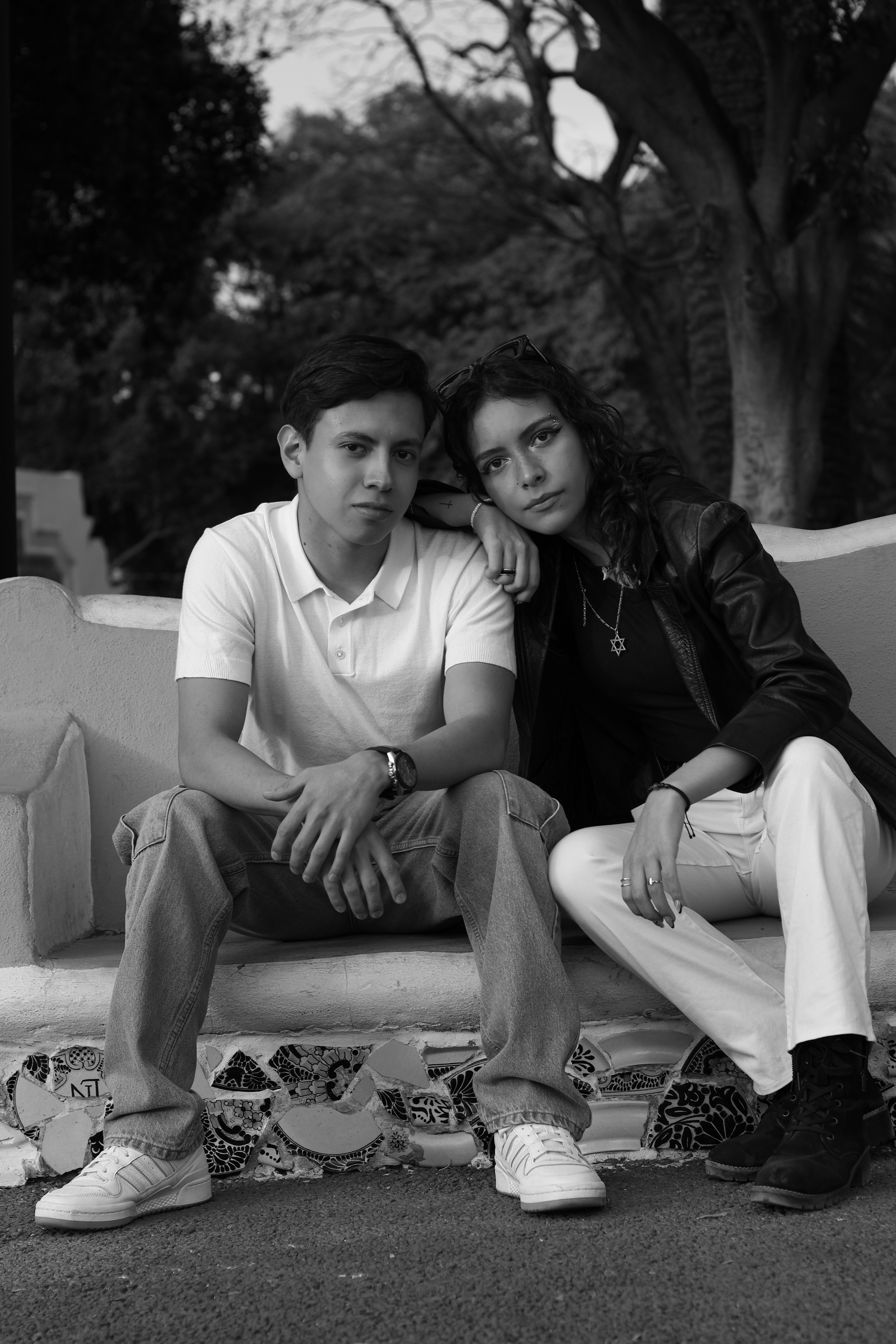 Young Couple Sitting on Outdoor Bench in Park · Free Stock Photo