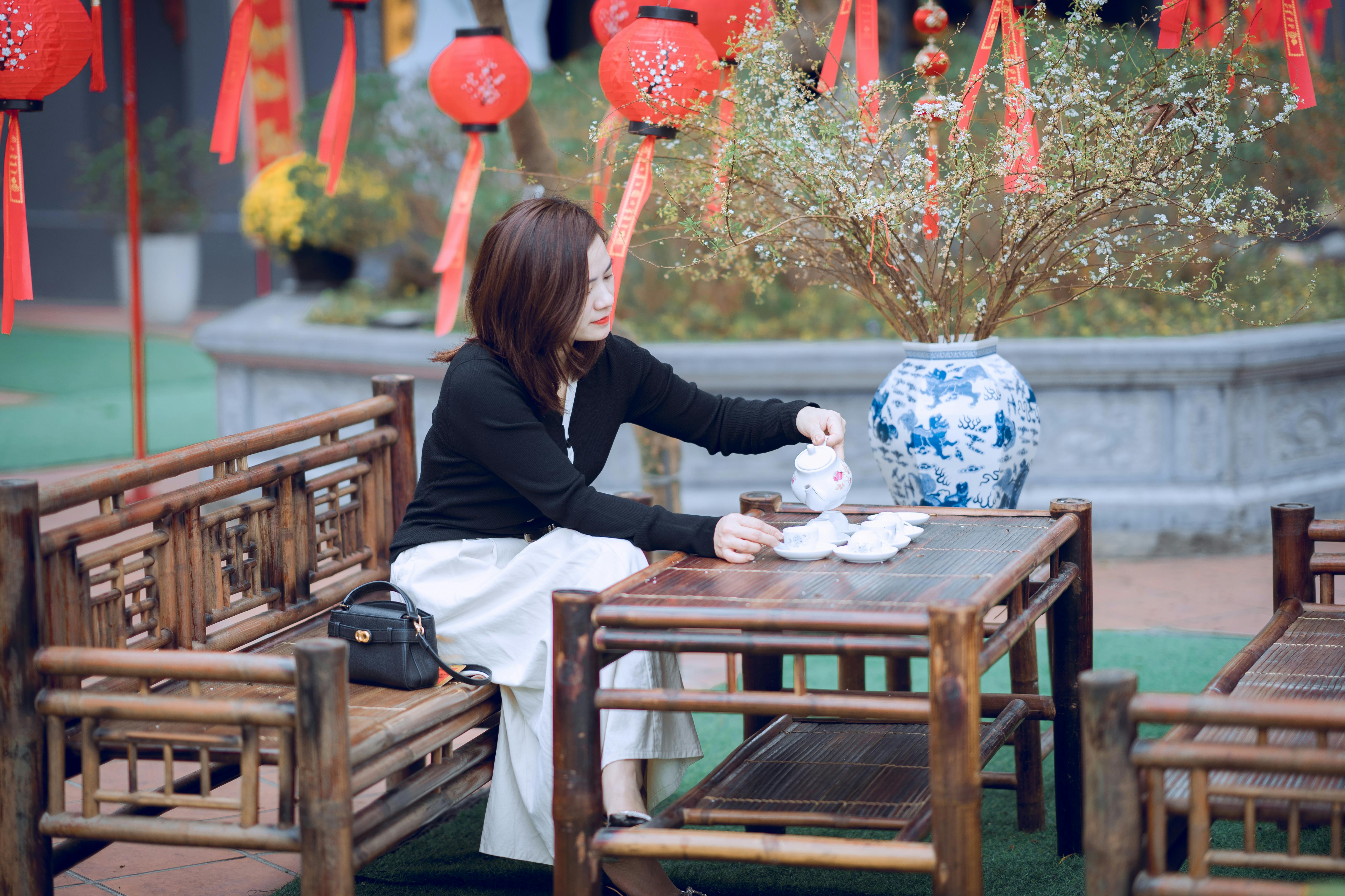 Woman Enjoying Tea in Traditional Asian Setting · Free Stock Photo