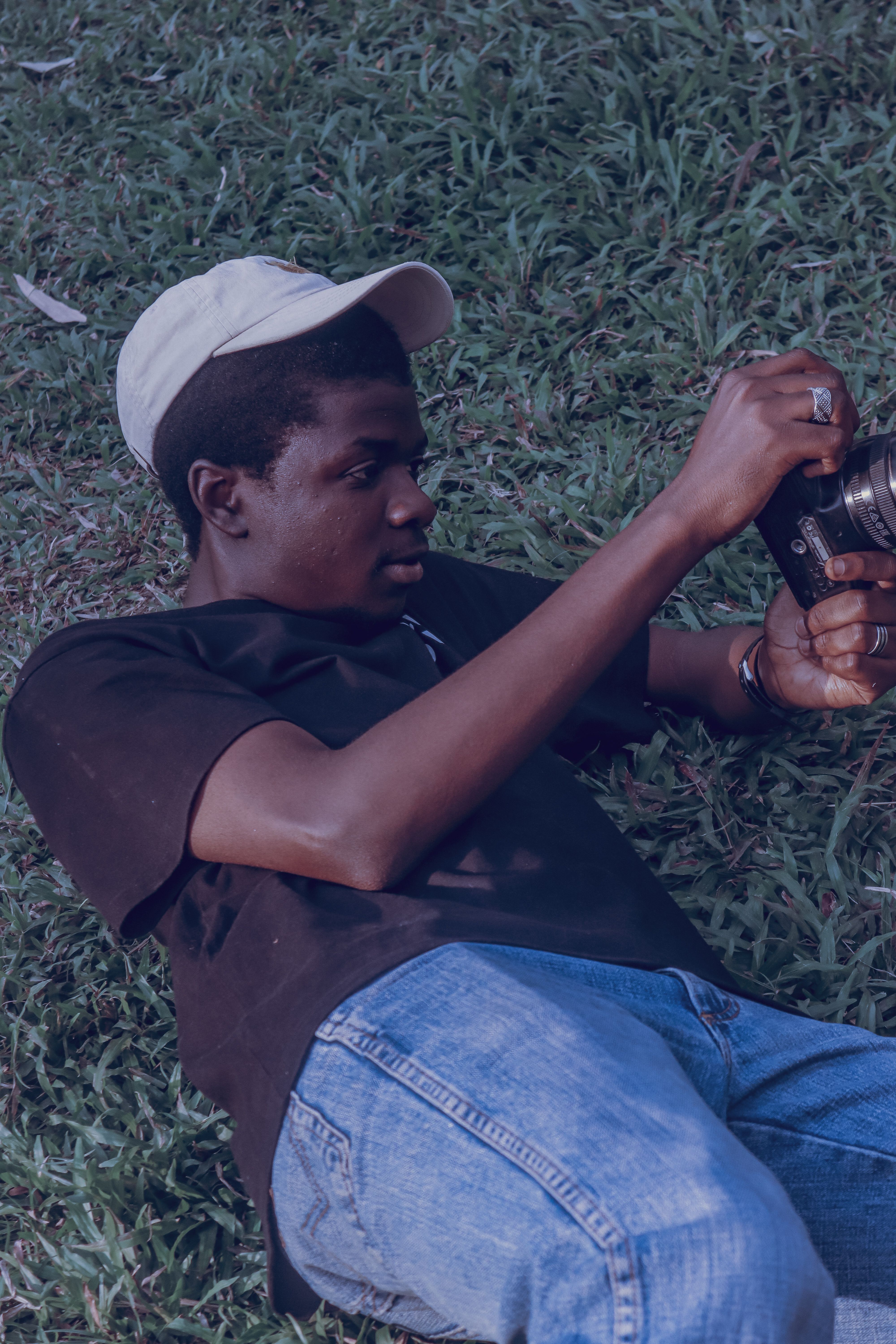 Young Photographer Relaxing Outdoors with Camera · Free Stock Photo