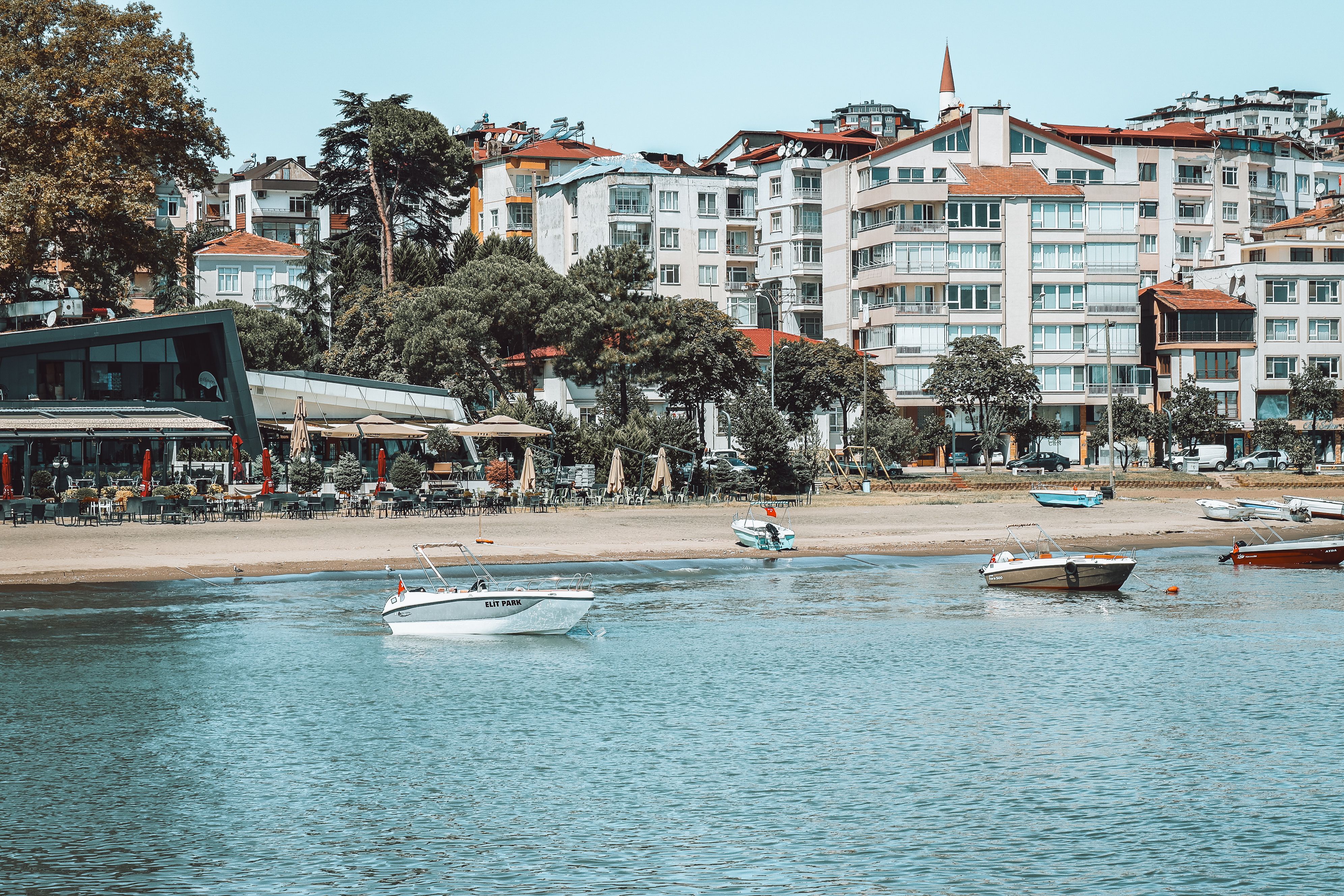 Coastal cityscape with boats and beachfront buildings · Free Stock Photo