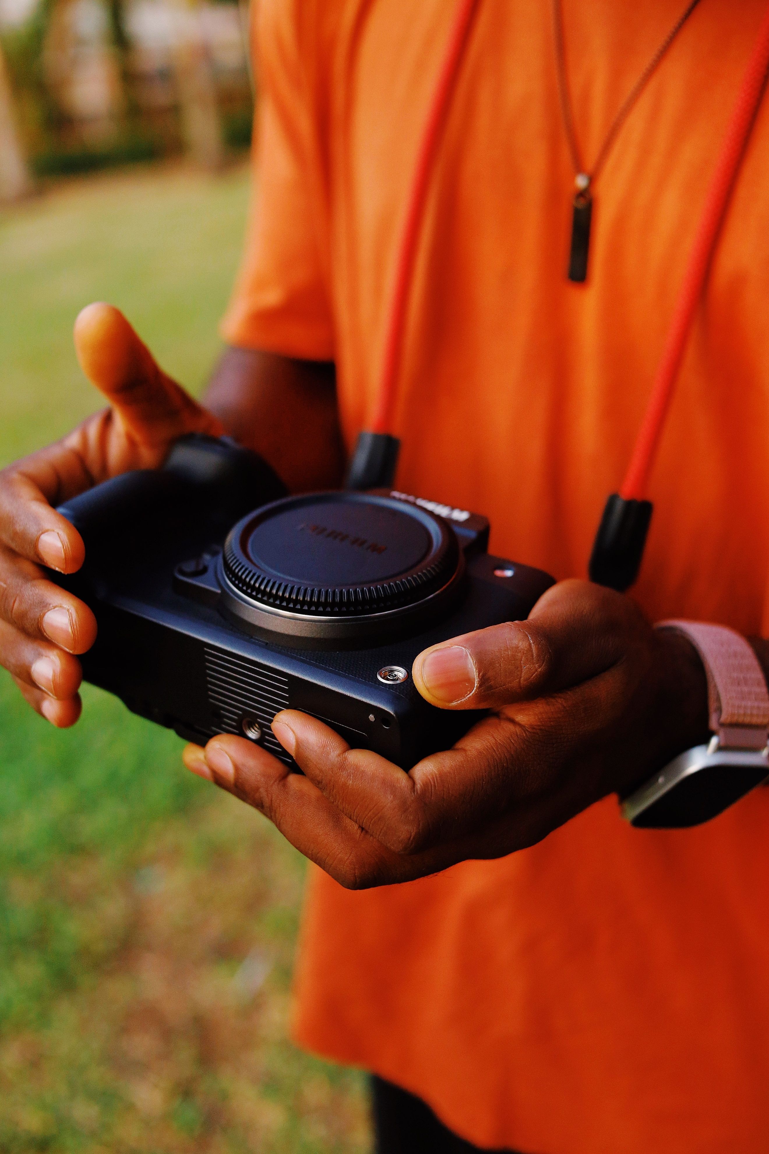 Person Holding Camera Outdoors in Abuja · Free Stock Photo