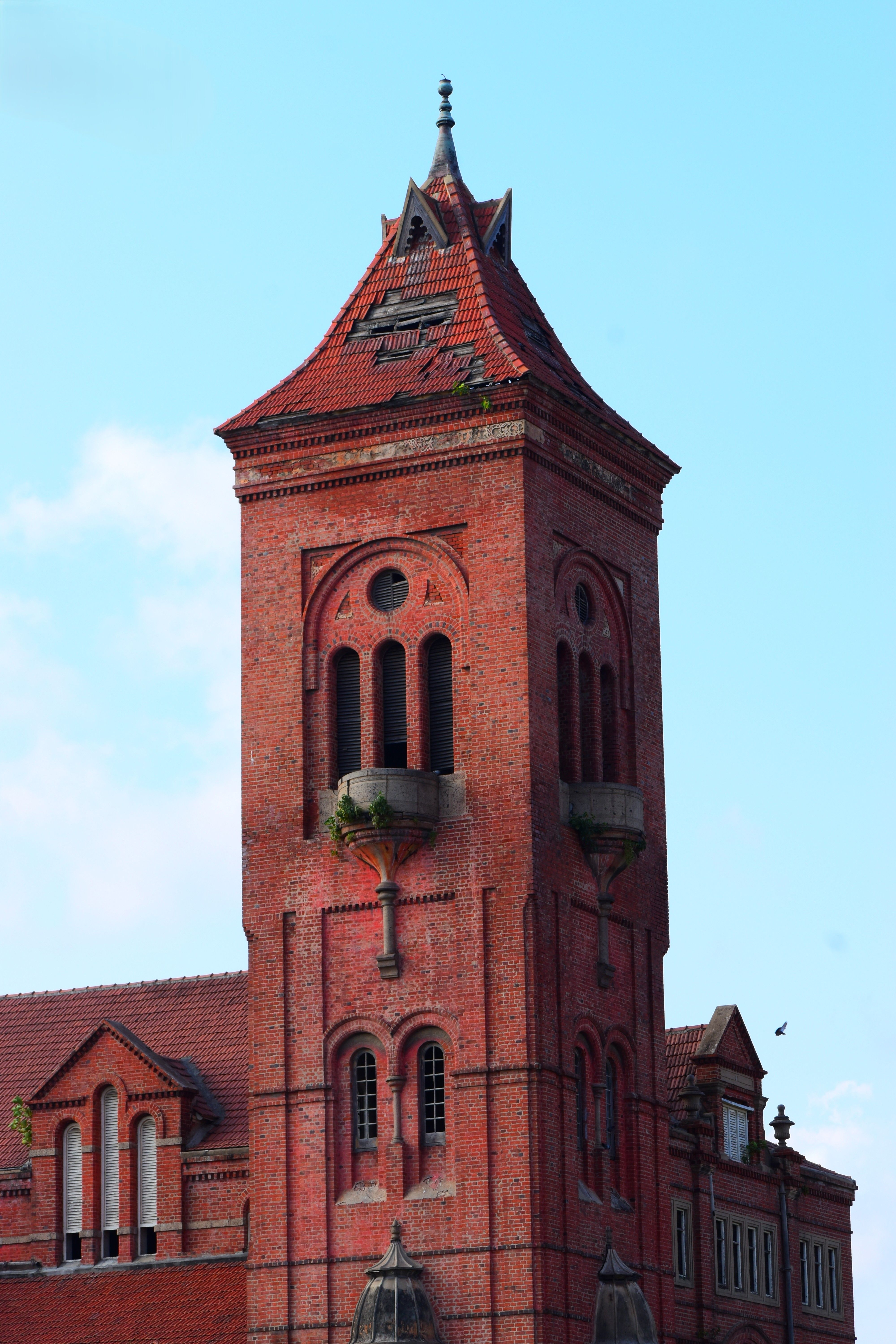 Historic Red Brick Tower of a Gothic Building · Free Stock Photo