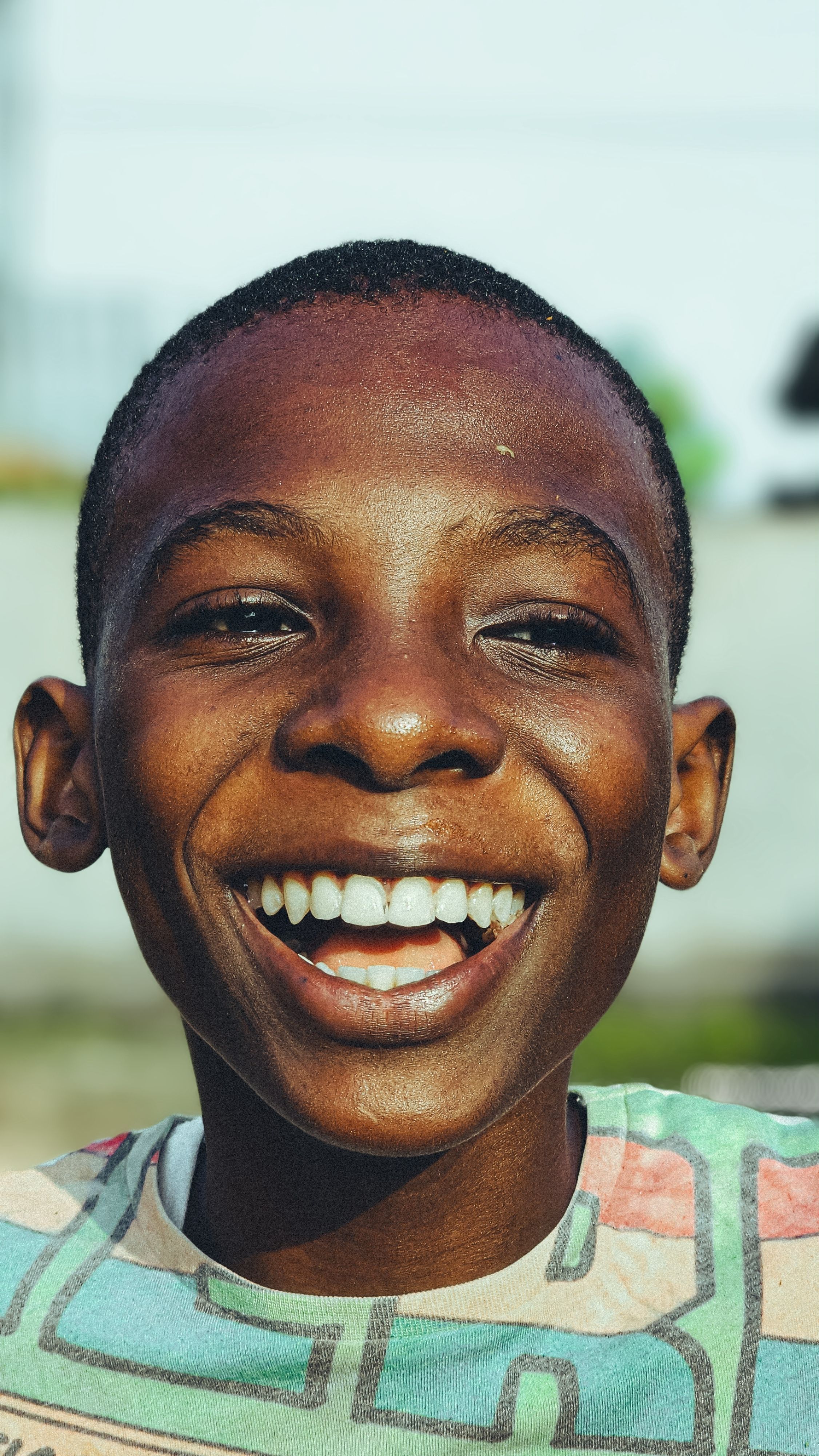 Joyful Portrait of a Smiling Teenager Outdoors · Free Stock Photo