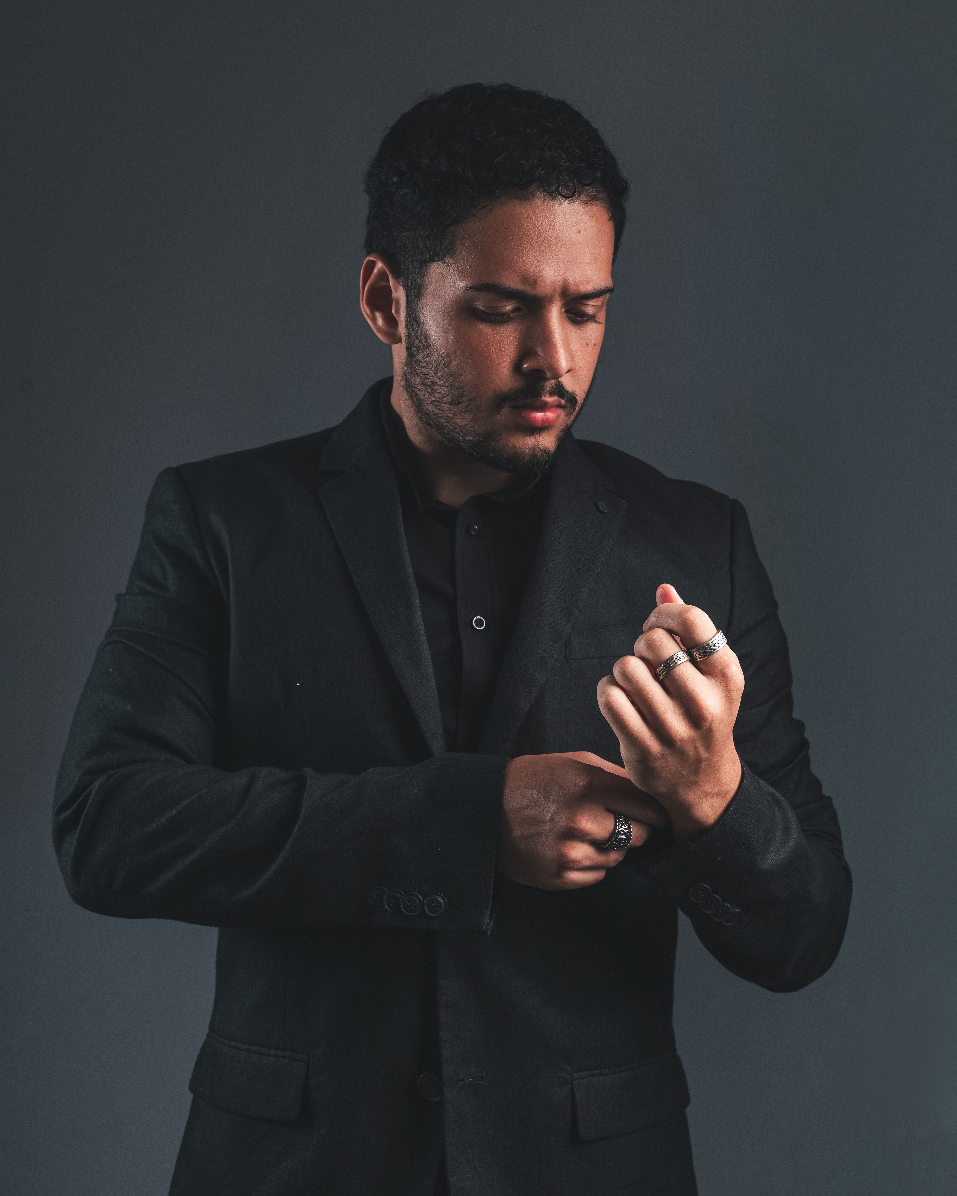 Confident Man in Black Suit Adjusting Cufflinks · Free Stock Photo