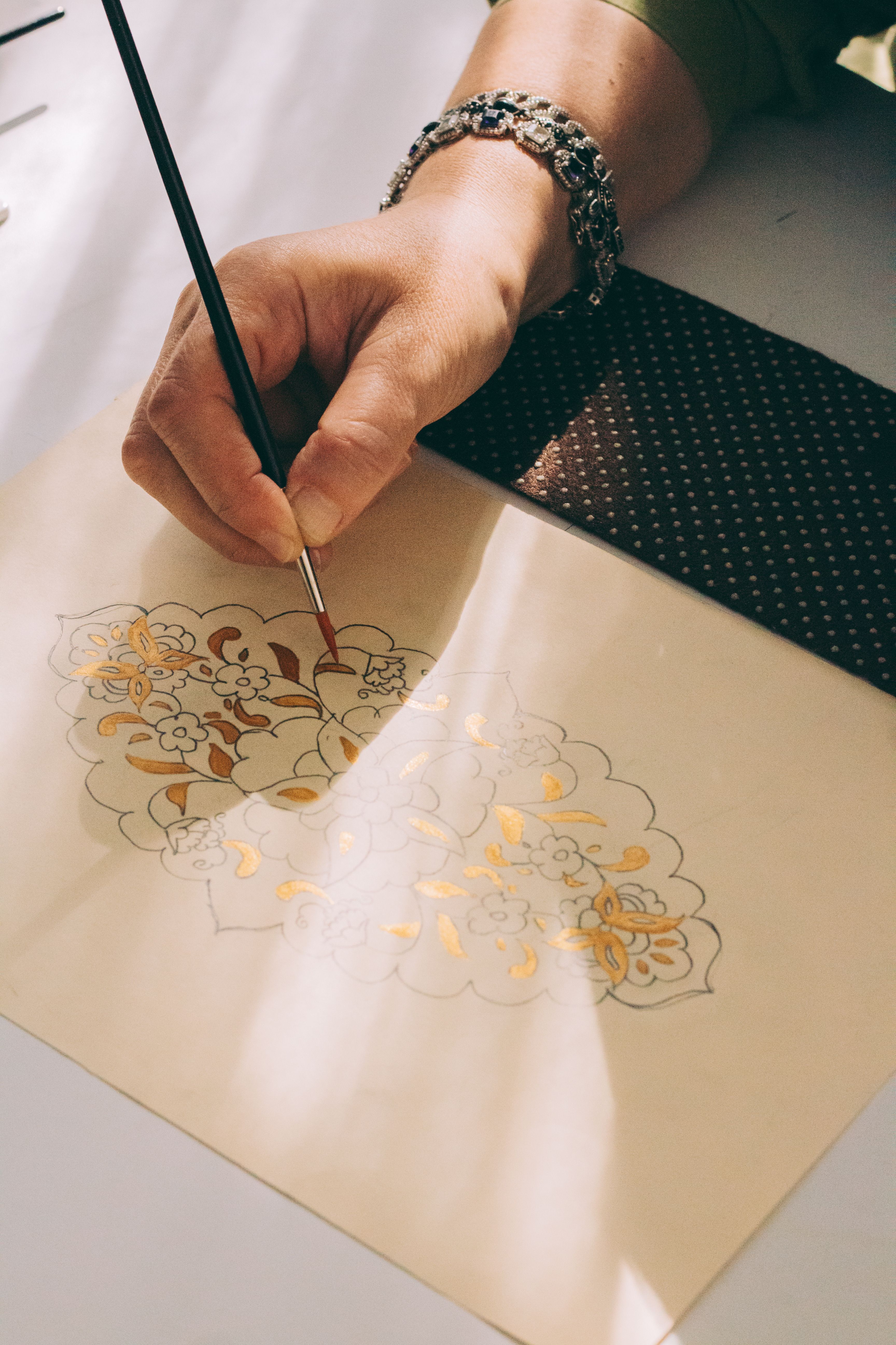 Artistic Hand Creating Intricate Floral Design · Free Stock Photo