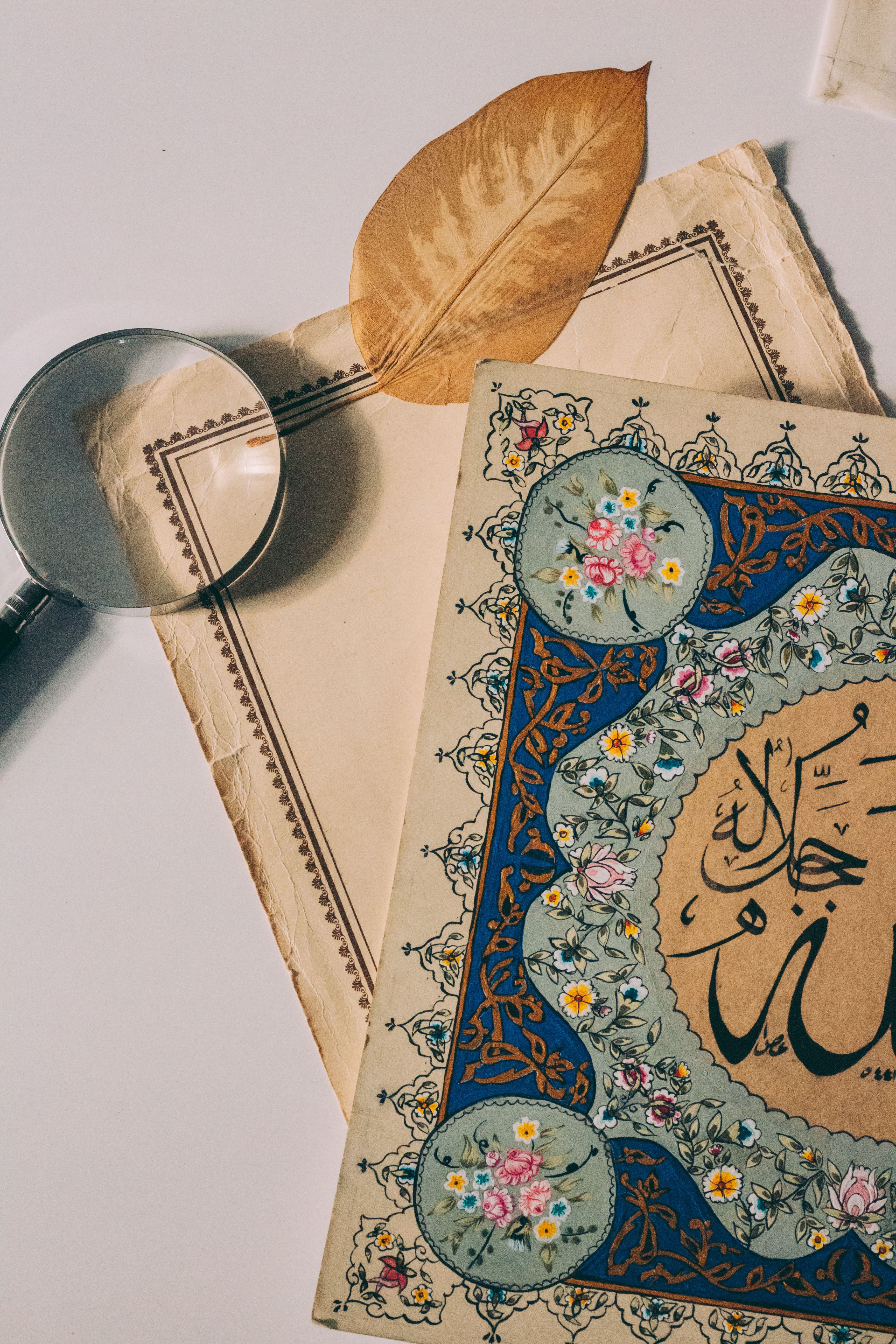 Vintage Calligraphy and Magnifying Glass Scene · Free Stock Photo