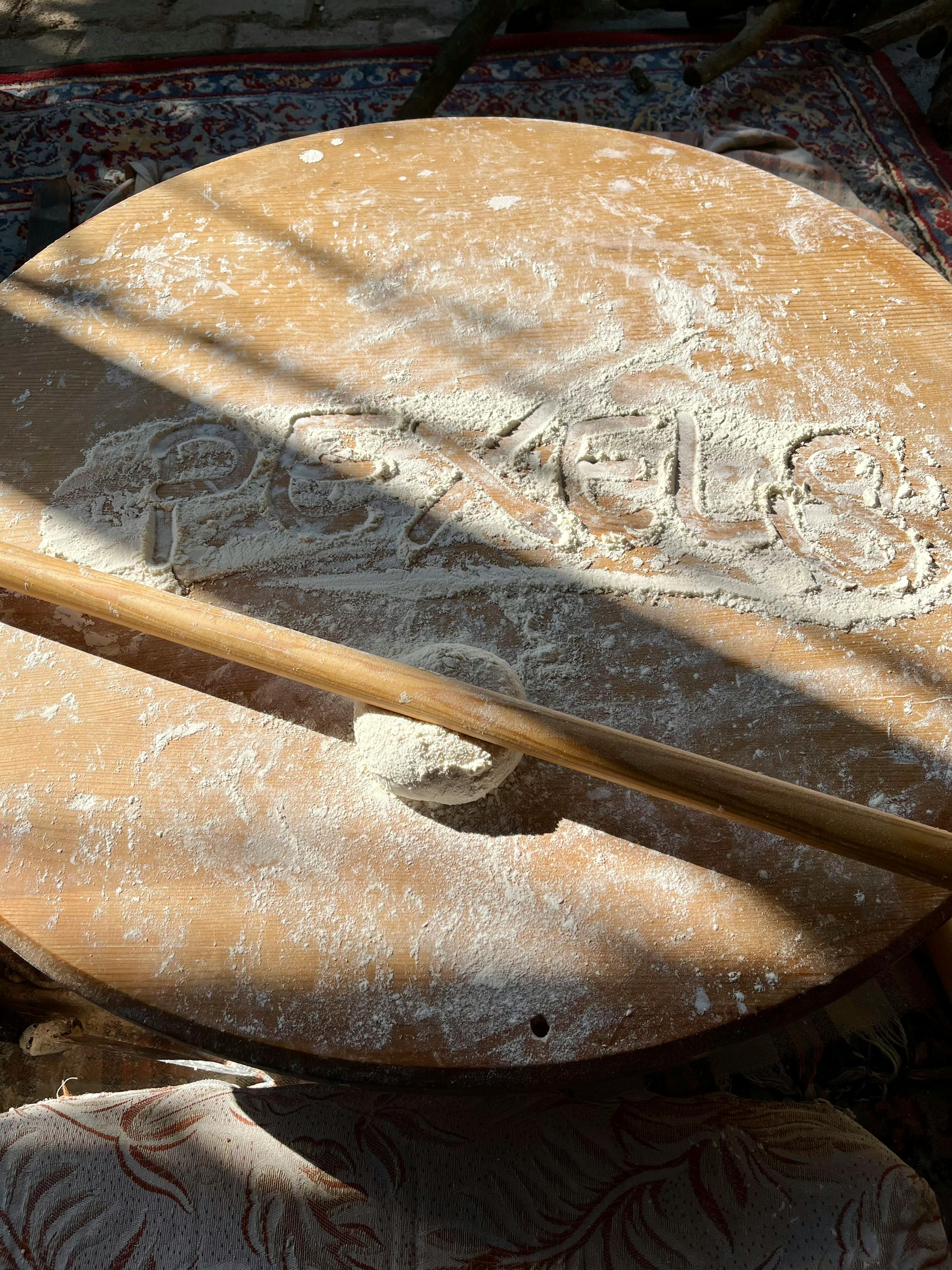 Flour-Covered Table with 'Pexels' Writing · Free Stock Photo