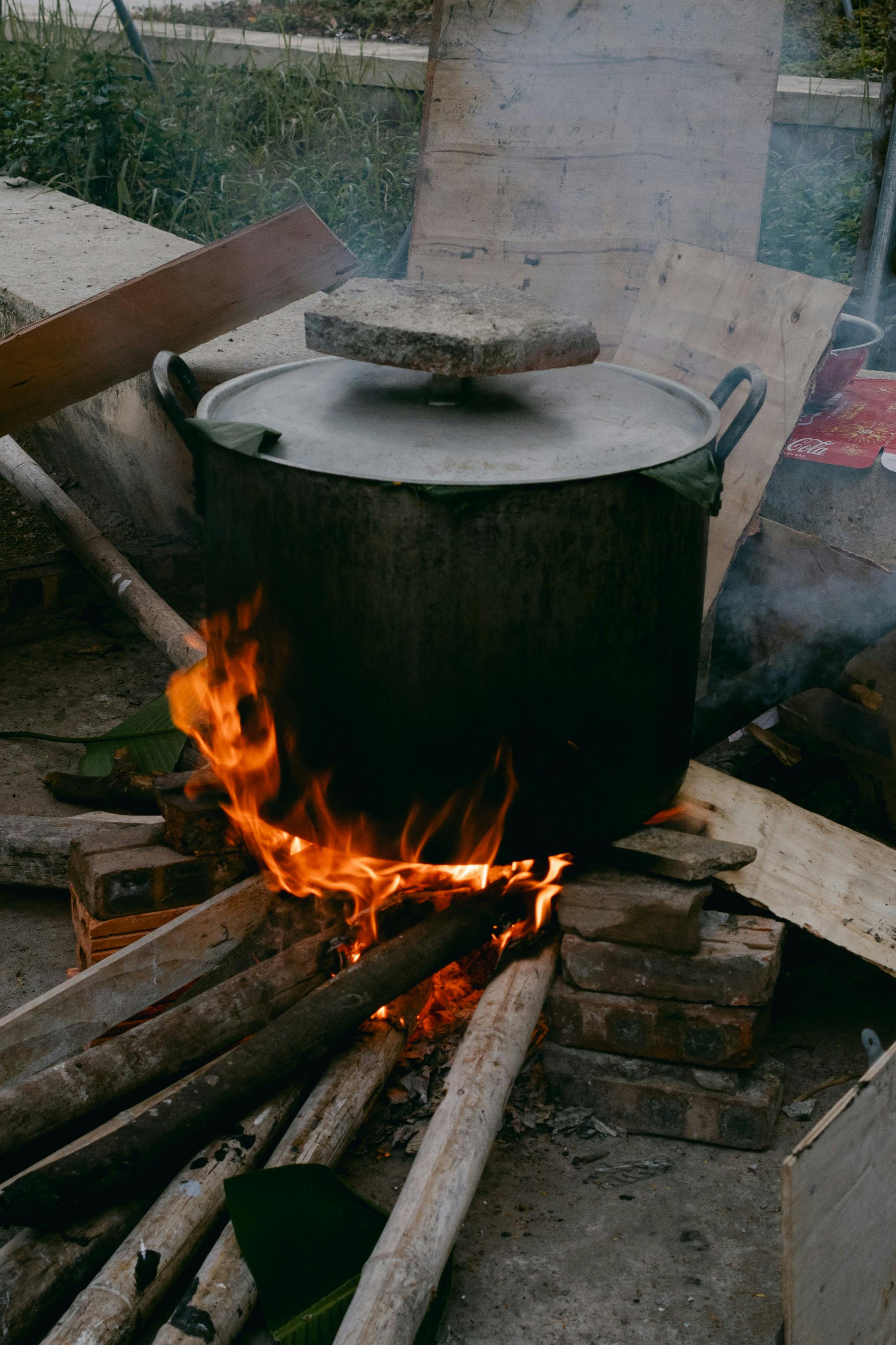 Rustic Outdoor Cooking with Firewood and Pot · Free Stock Photo