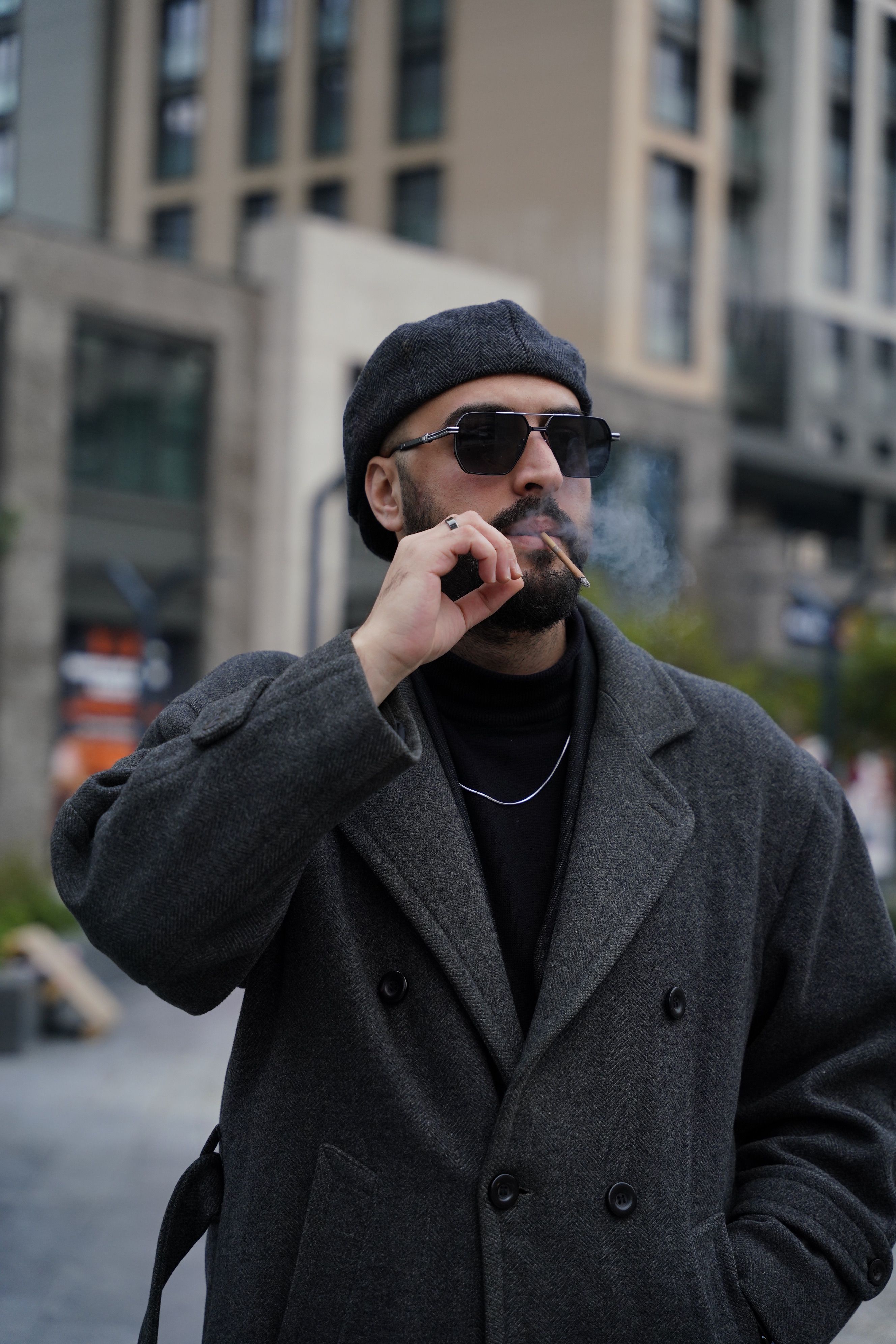 Stylish Man Smoking in Urban Setting · Free Stock Photo