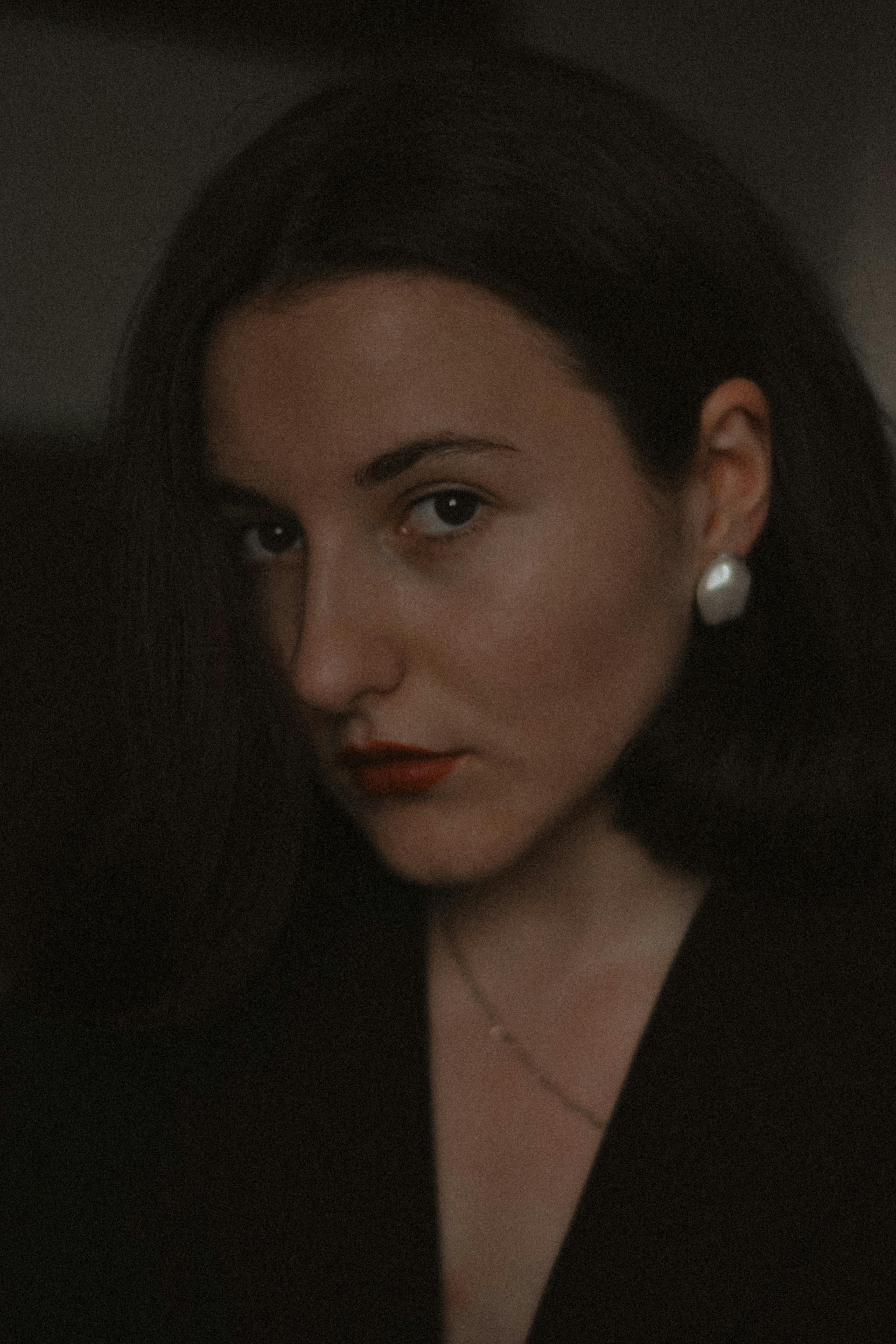 Moody Portrait of a Woman in Low Light · Free Stock Photo