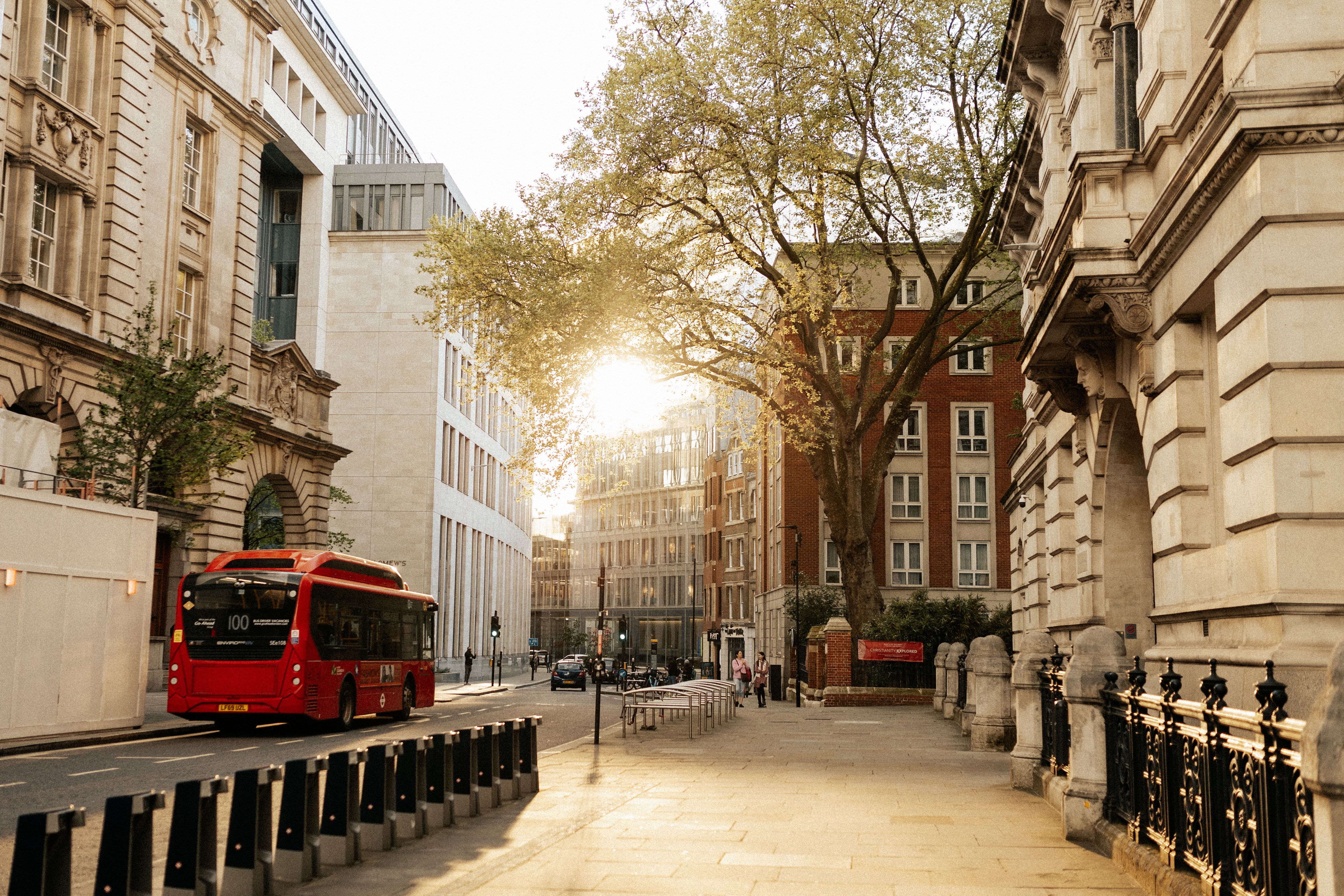 Red Double-Decker Bus on a London Street at Sunset · Free Stock Photo