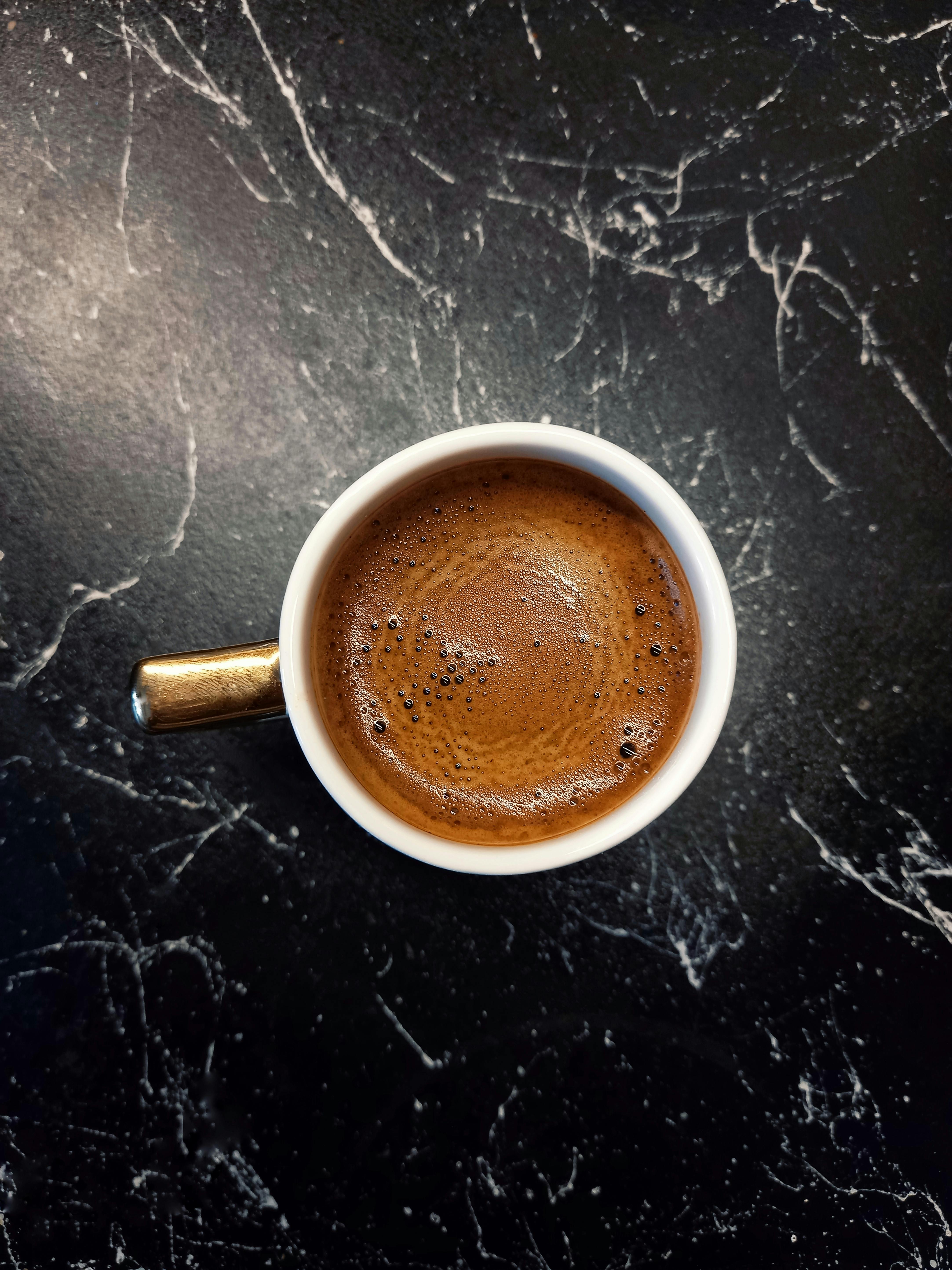 Aerial View of Espresso in White Cup on Marble Surface · Free Stock Photo