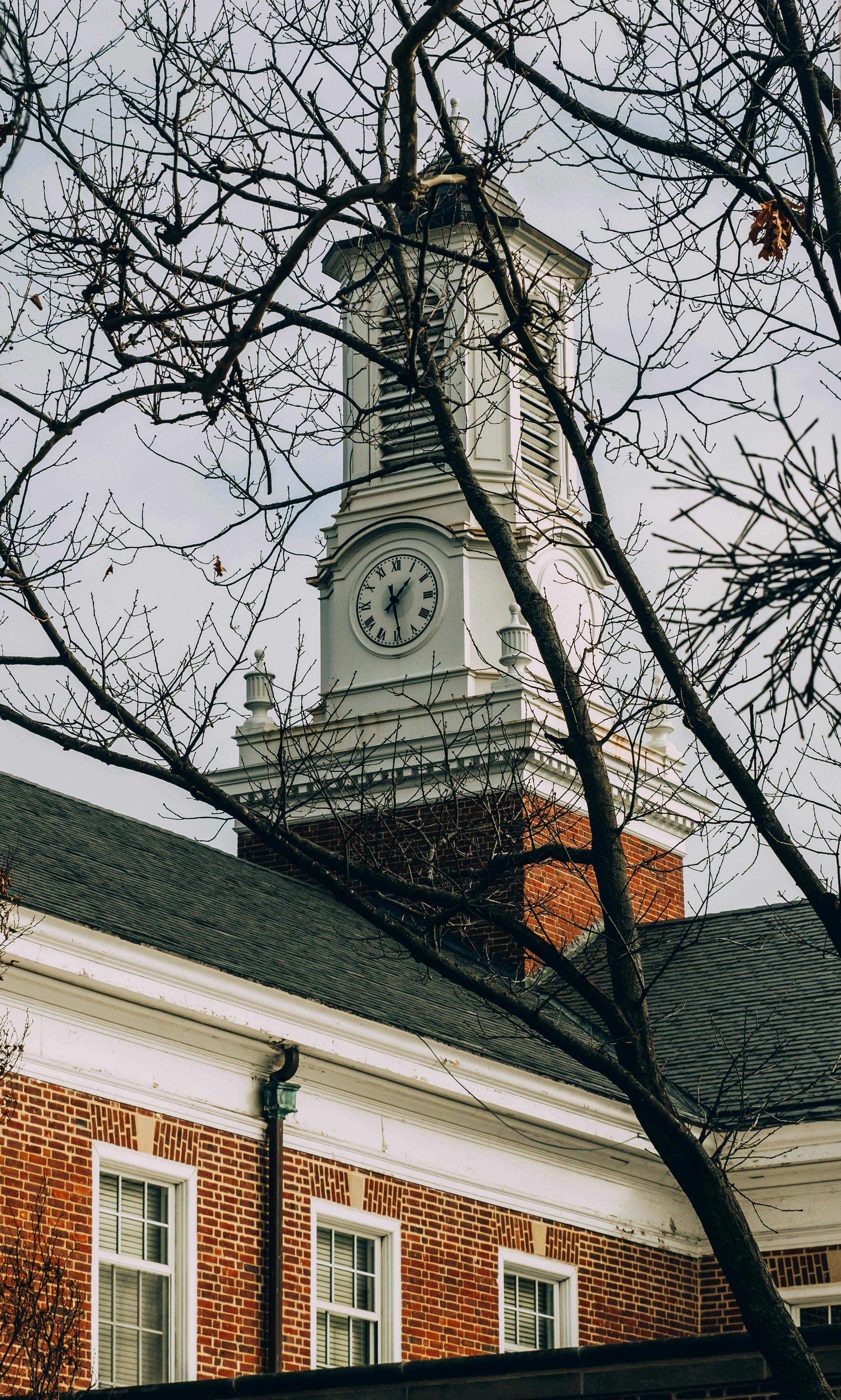 Historic Brick Clock Tower in Winter Scene · Free Stock Photo