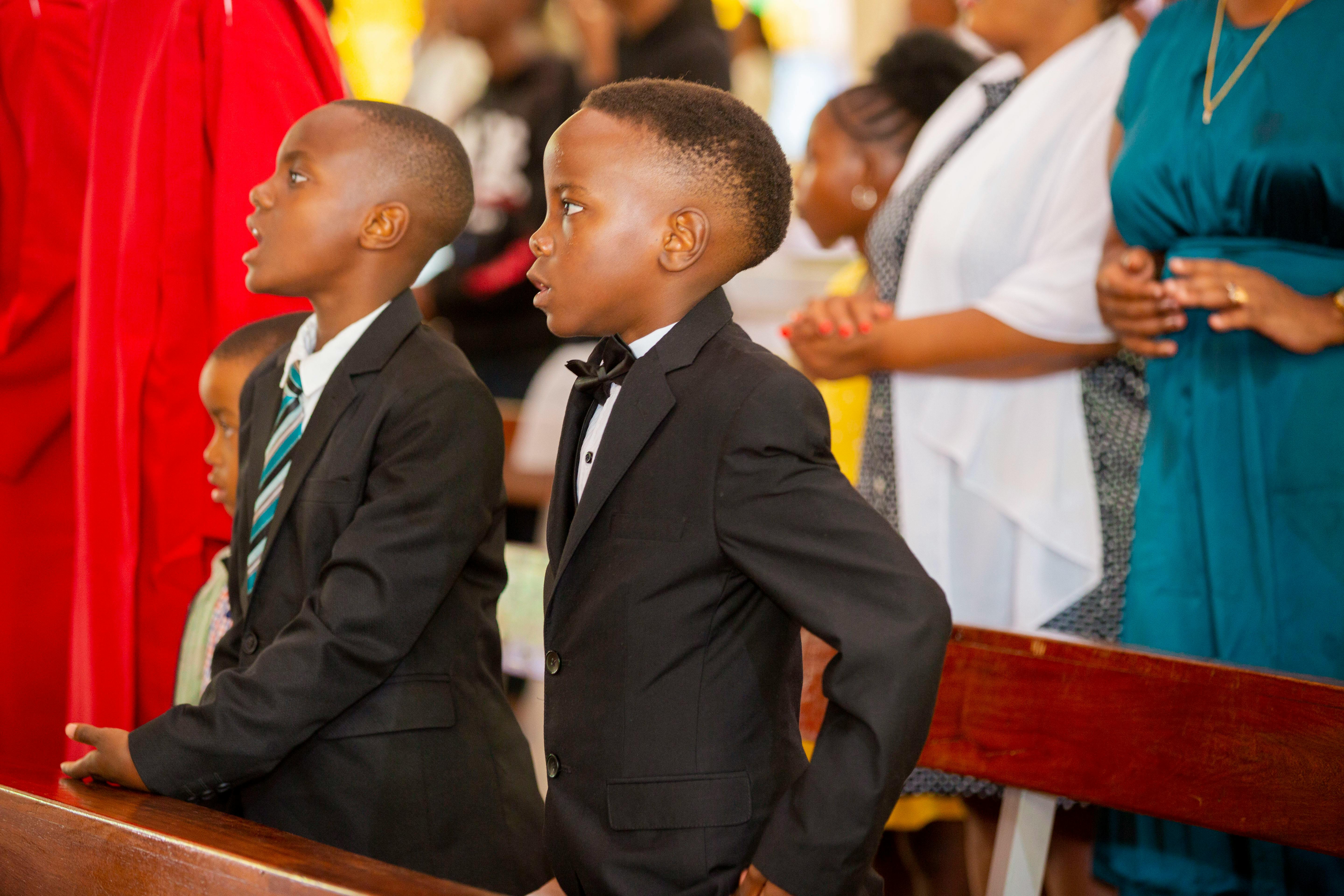 Young Boys in Suits Attending a Church Ceremony · Free Stock Photo