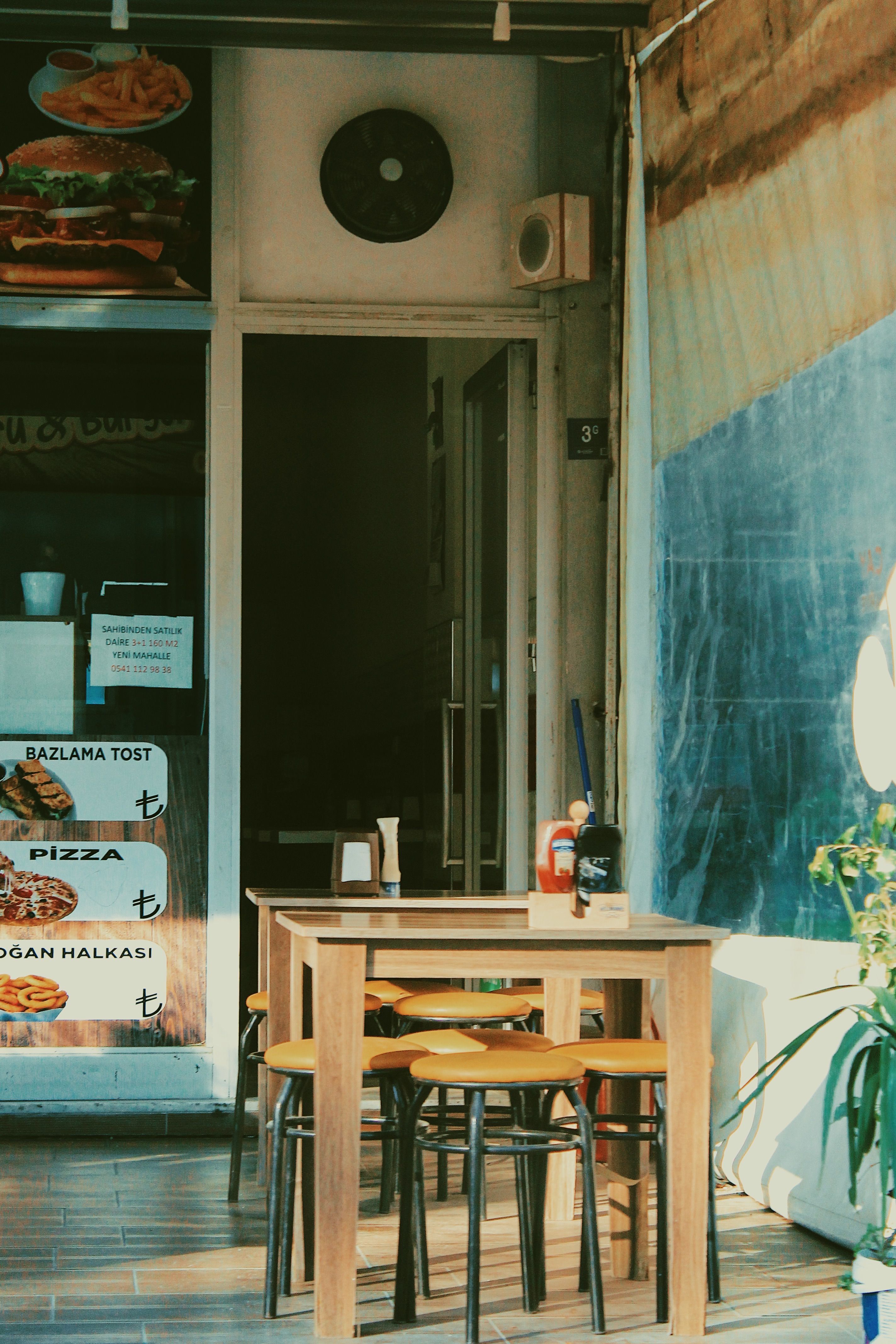 Cozy Outdoor Cafe Seating with Menu Signs · Free Stock Photo