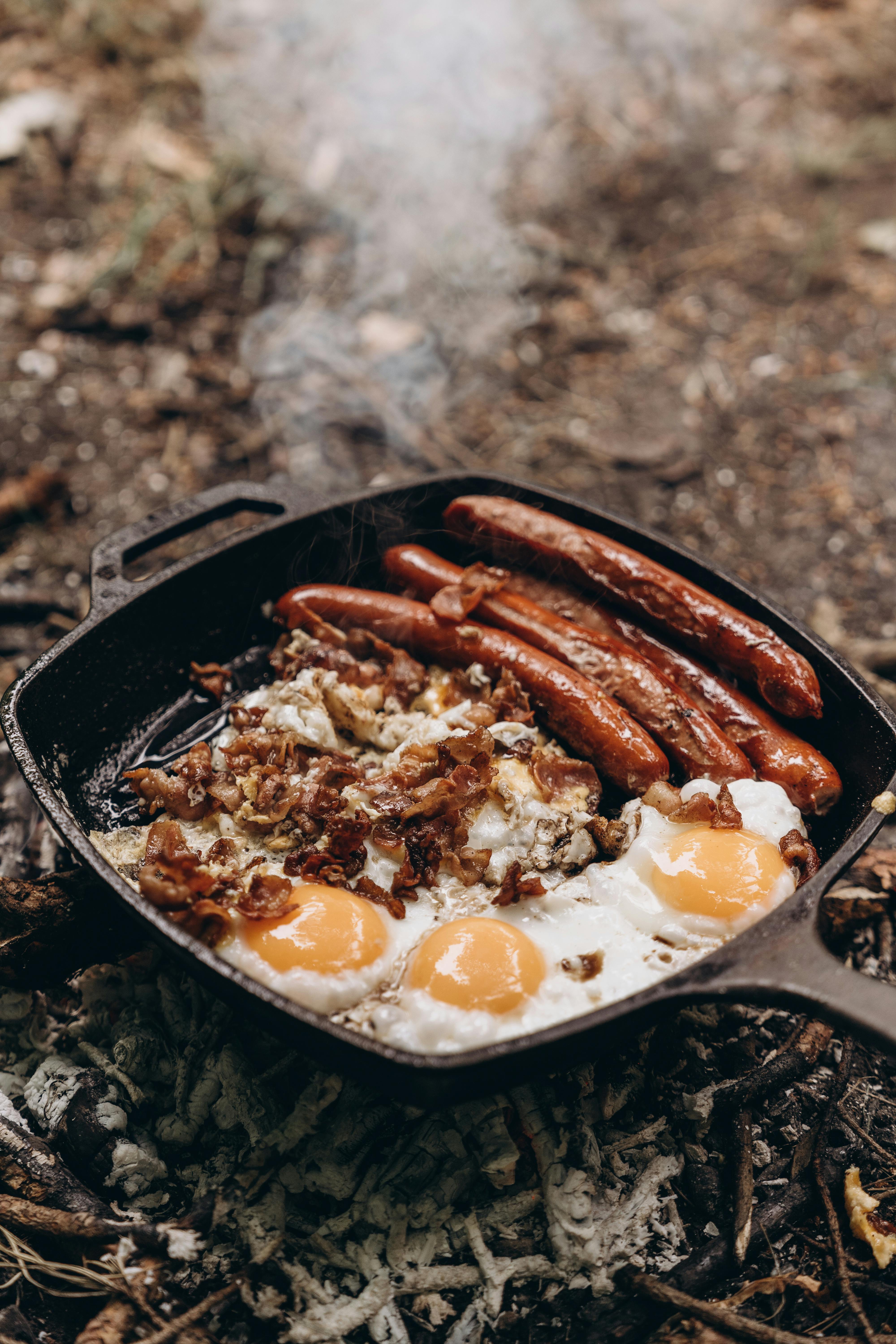 Rustic Campfire Breakfast with Eggs and Sausages · Free Stock Photo