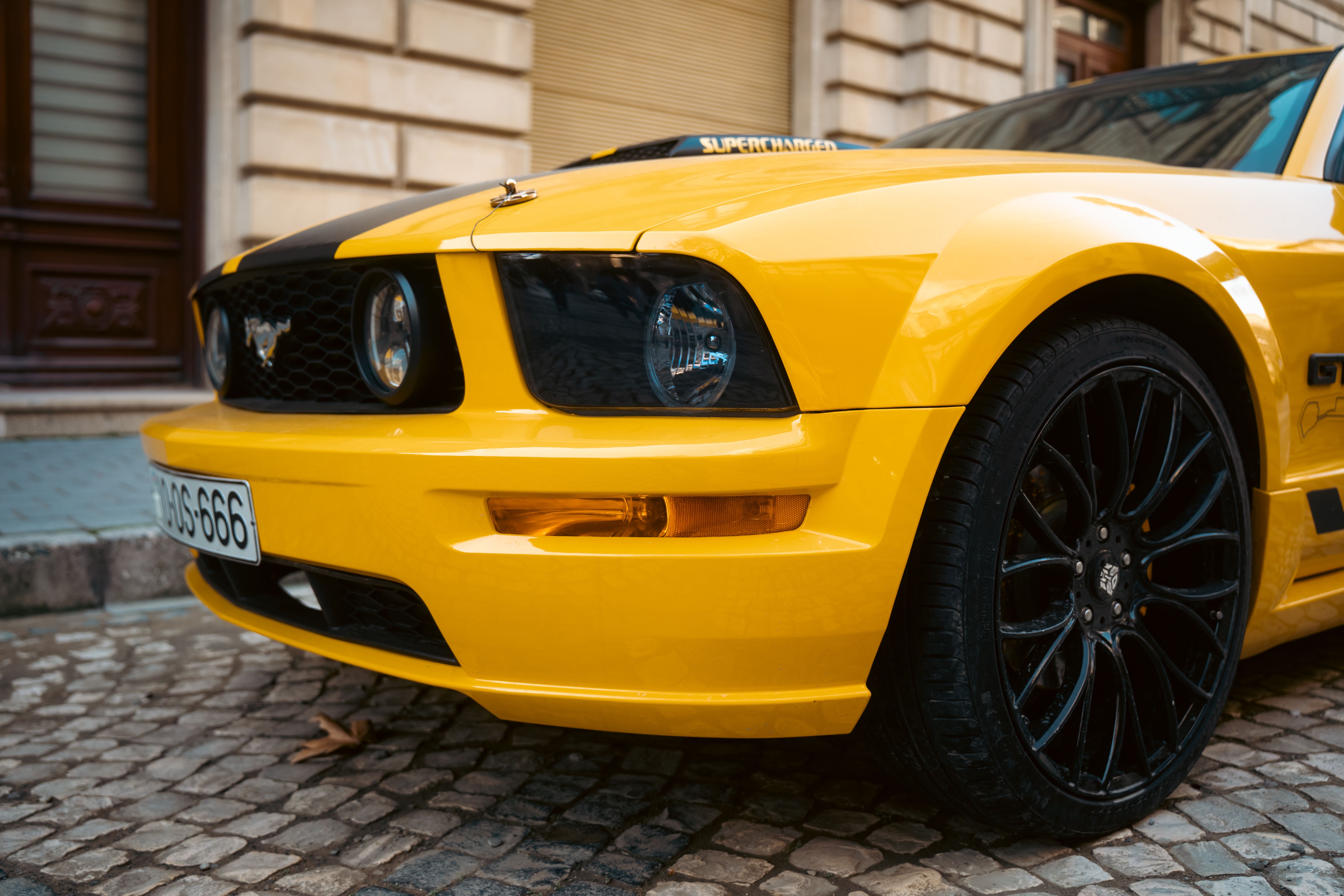 Yellow Ford Mustang on Cobblestone Street in Baku · Free Stock Photo