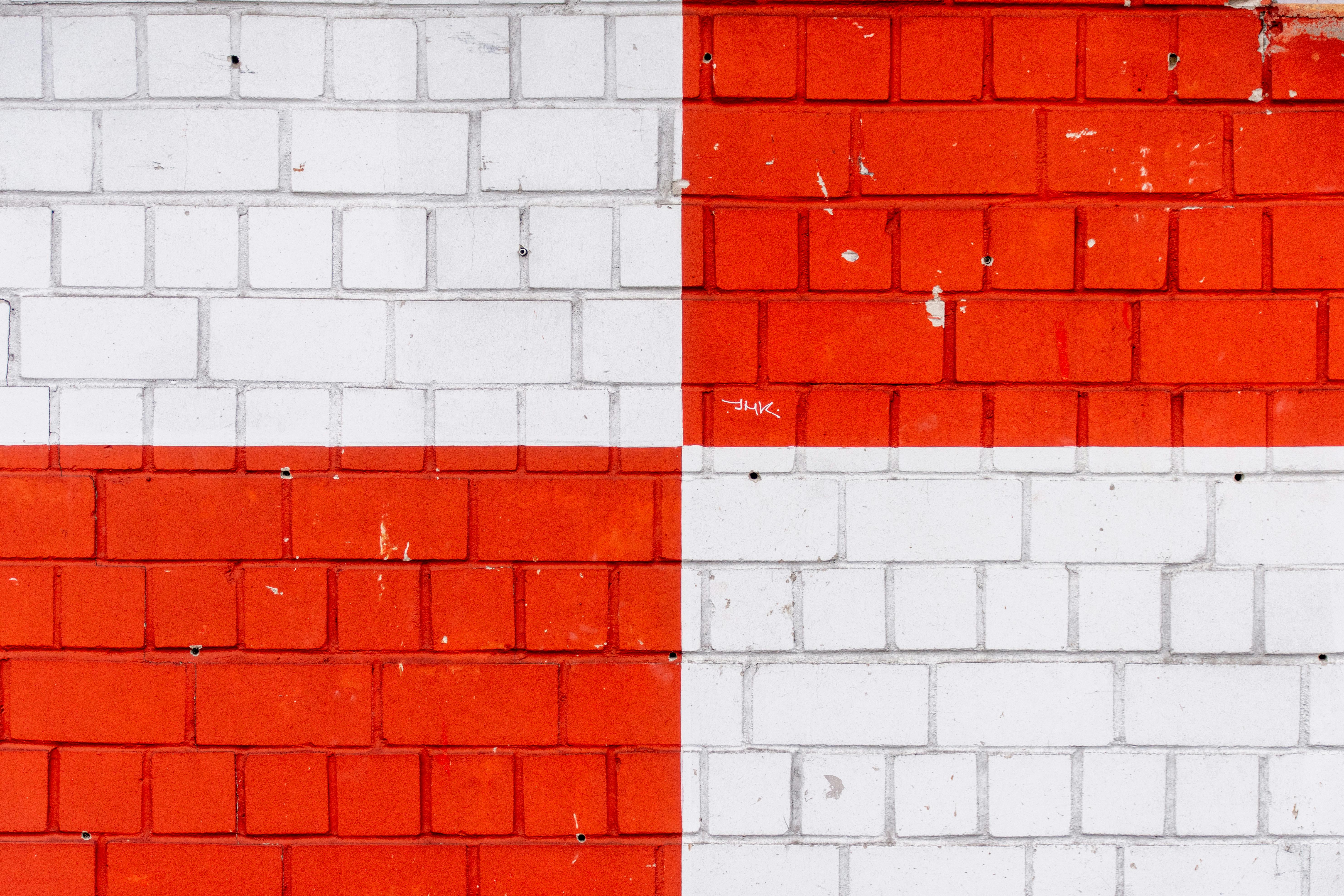 Modern Brick Wall with Painted Red and White Design · Free Stock Photo
