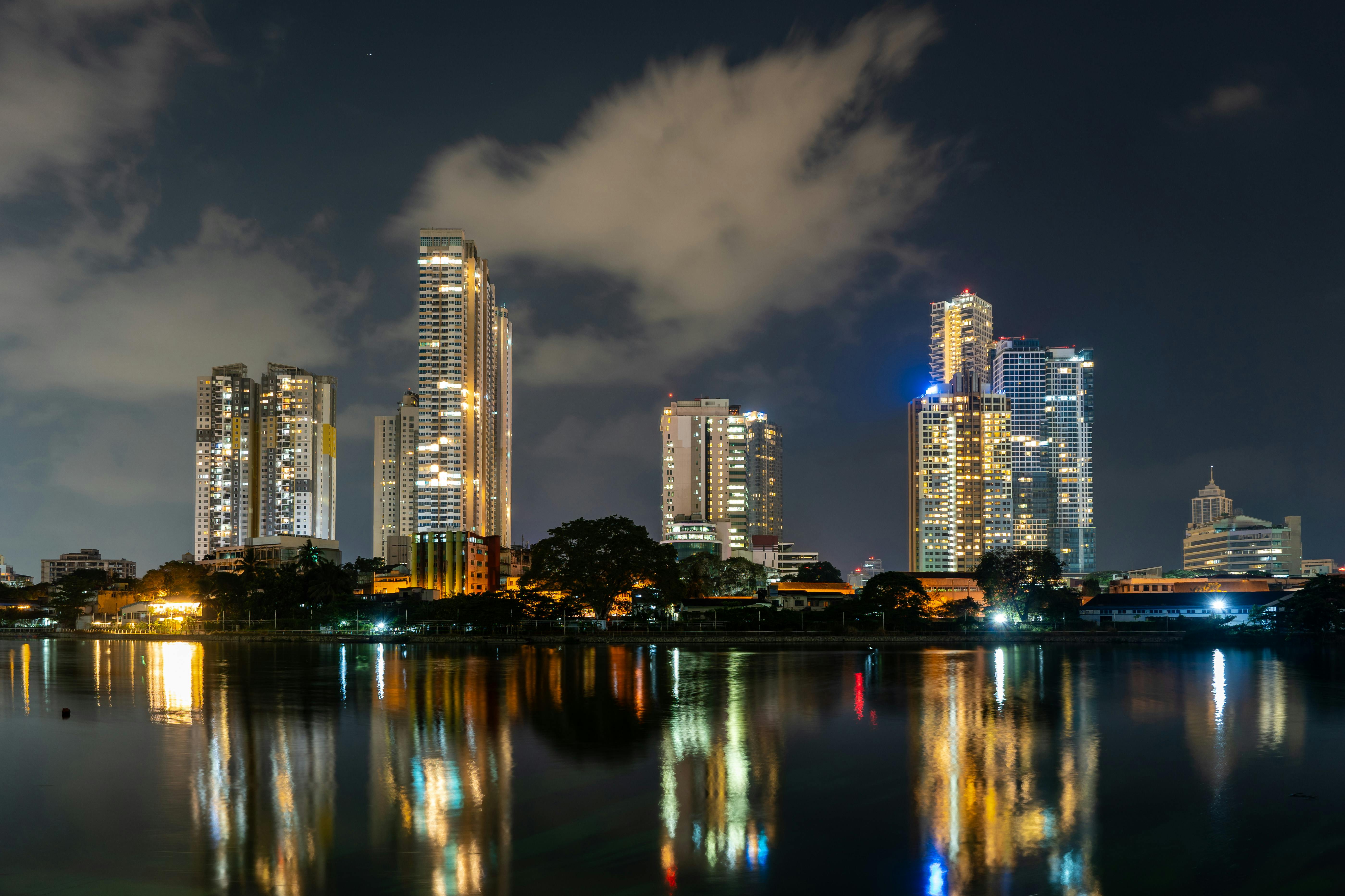 Stunning Nighttime Skyline Reflection on Water · Free Stock Photo