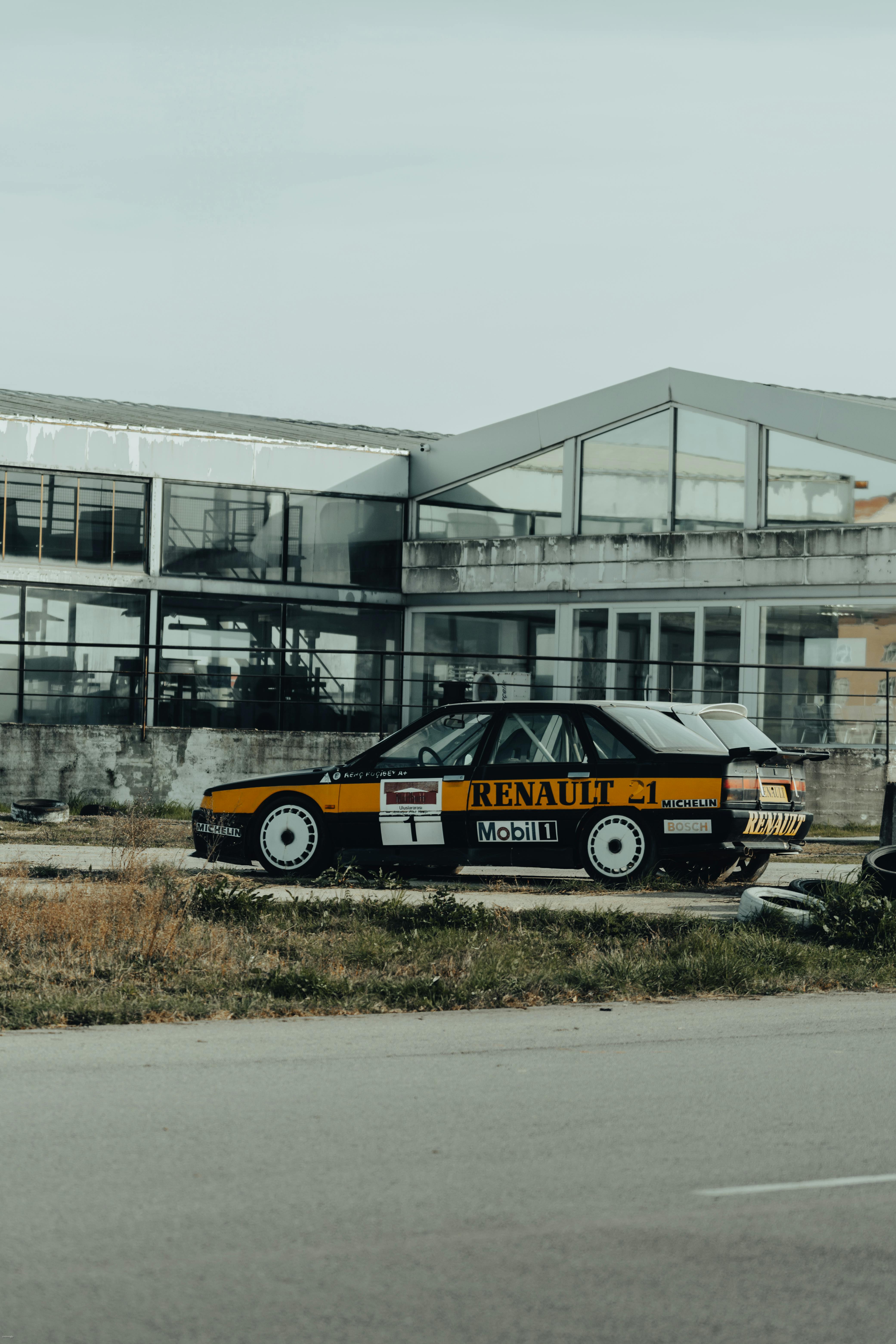 Classic Renault Race Car by Industrial Building · Free Stock Photo
