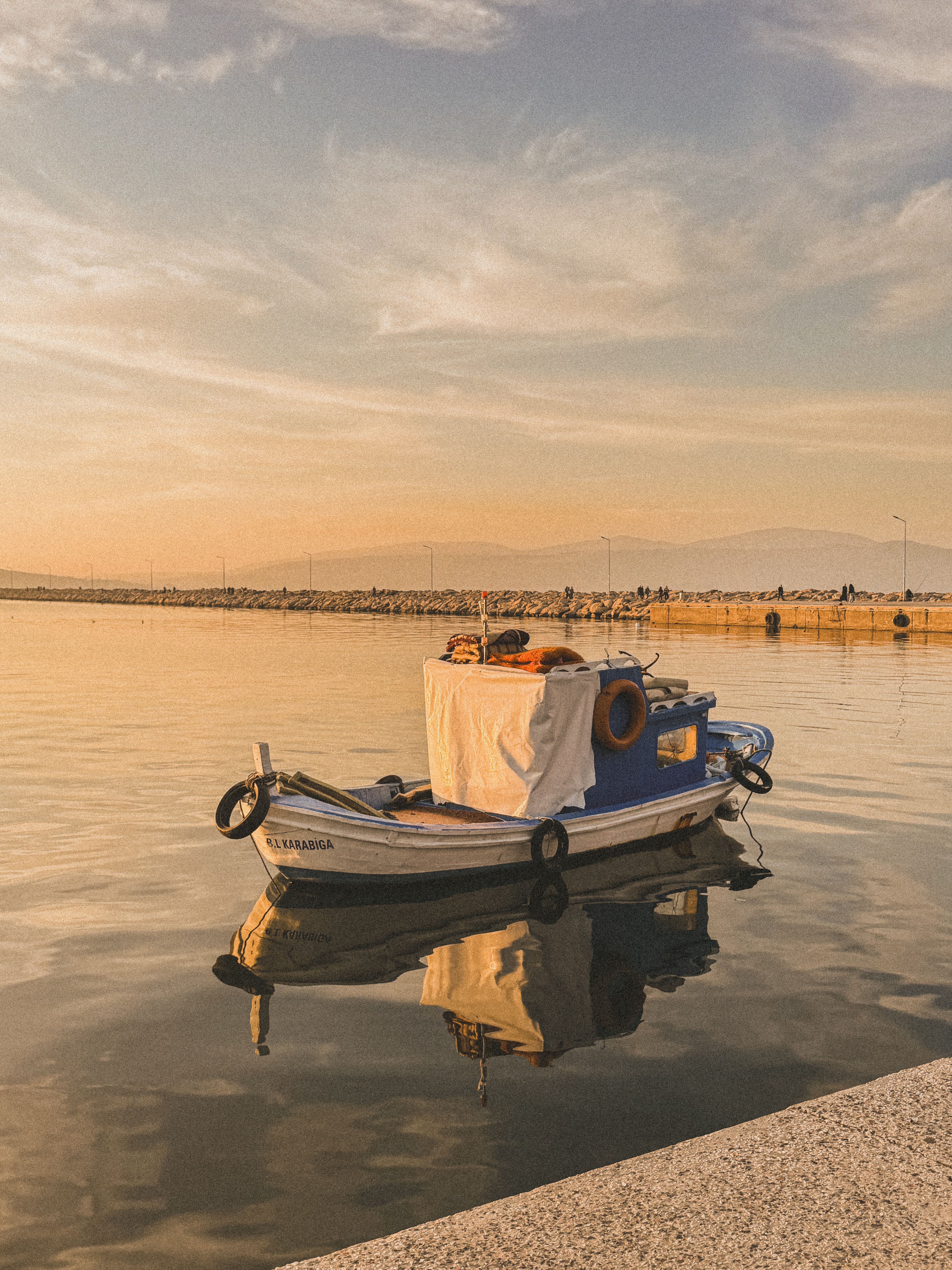 Serene Fishing Boat at Sunset on Calm Waters · Free Stock Photo