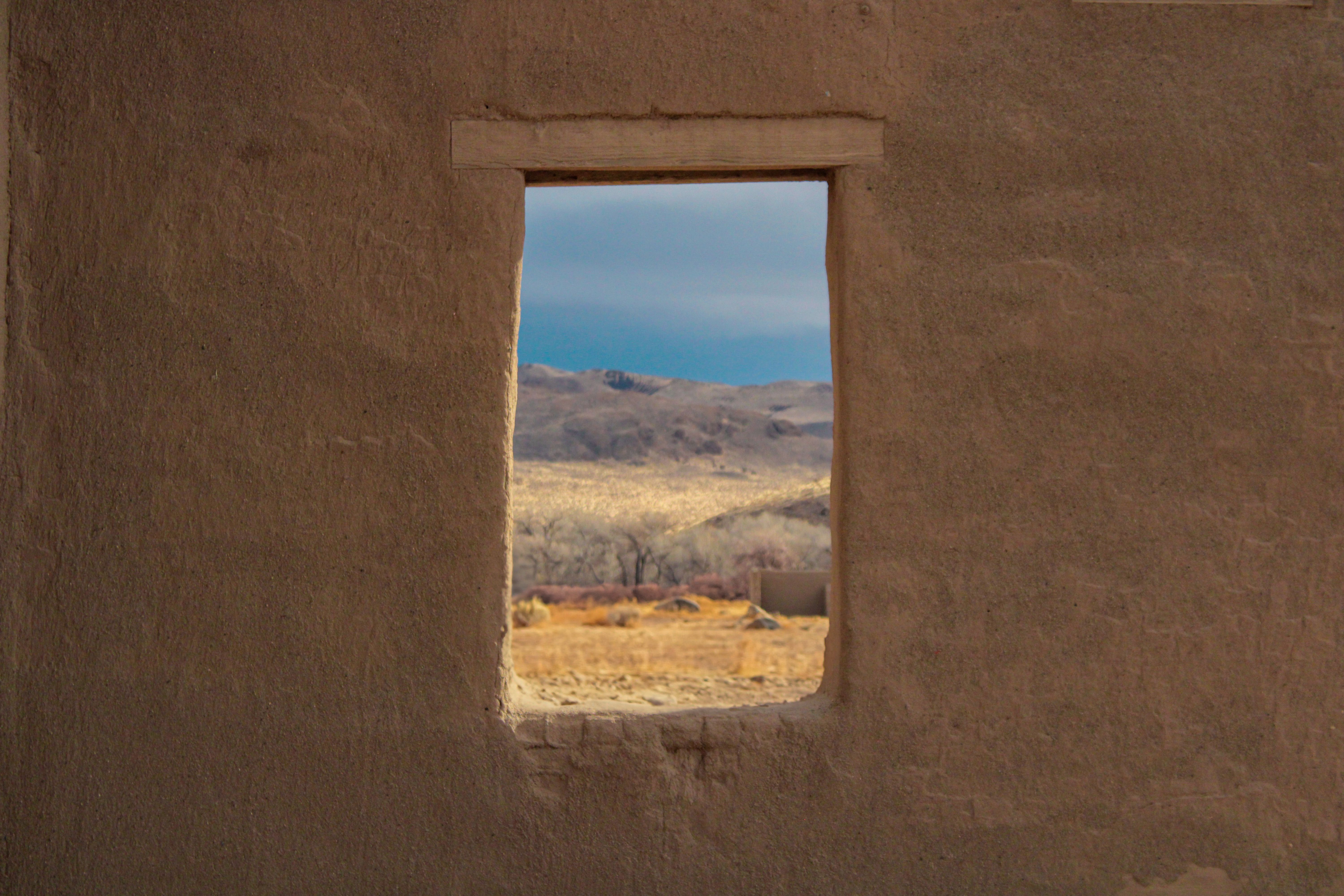 Ancient Architecture Window Framing Desert Landscape · Free Stock Photo