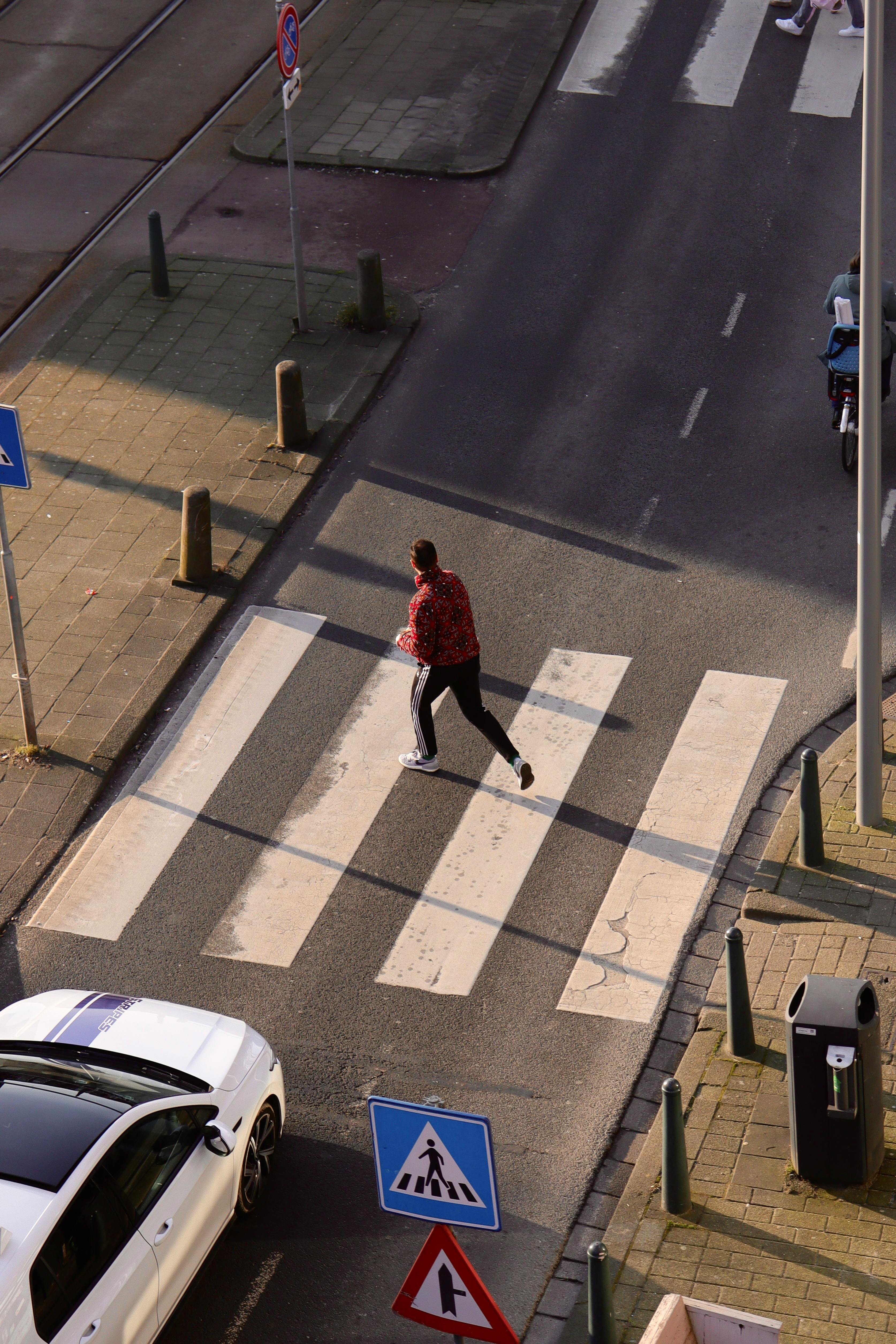 Pedestrian Crossing a City Street at Crosswalk · Free Stock Photo