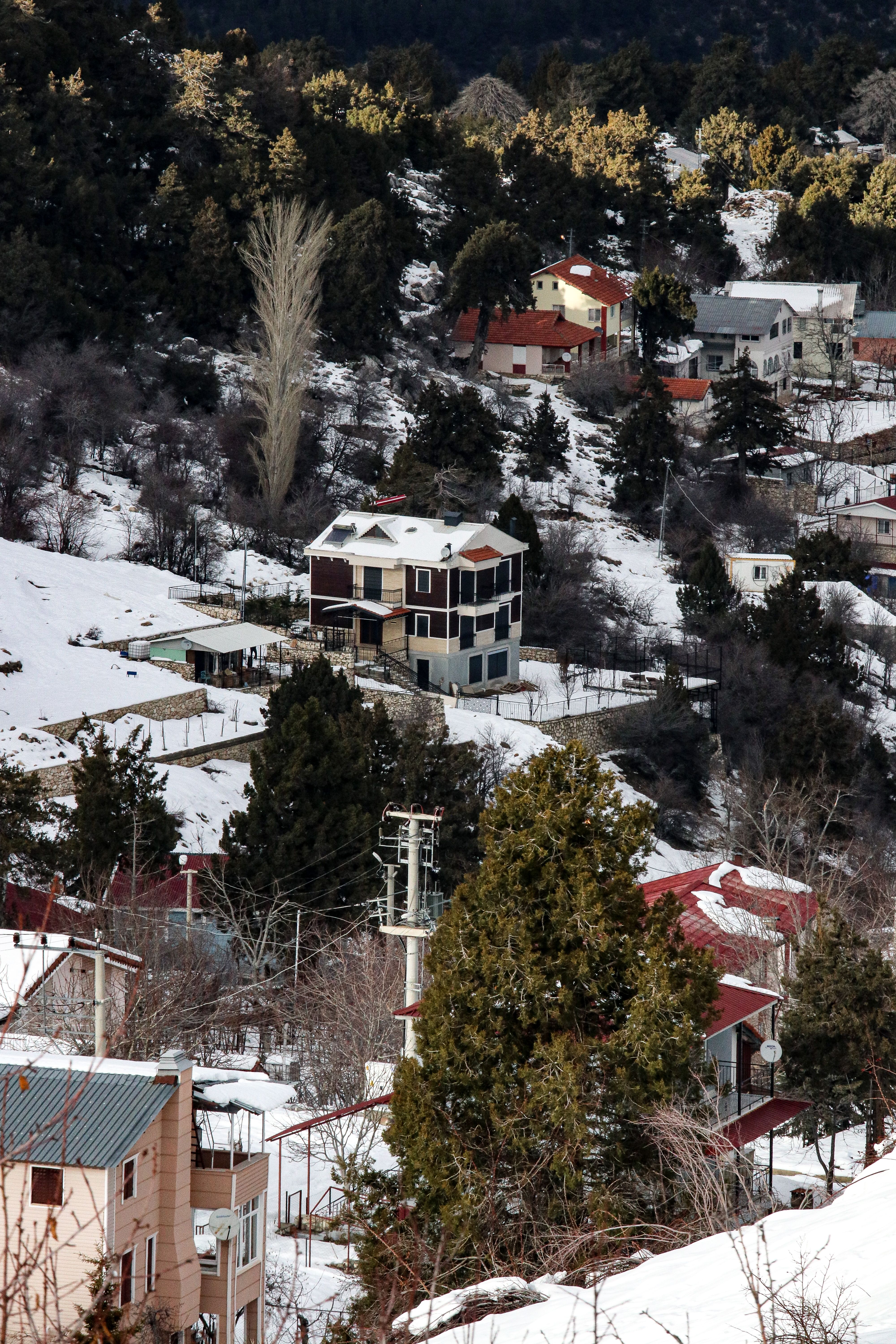 Snow-covered hillside village in winter landscape · Free Stock Photo