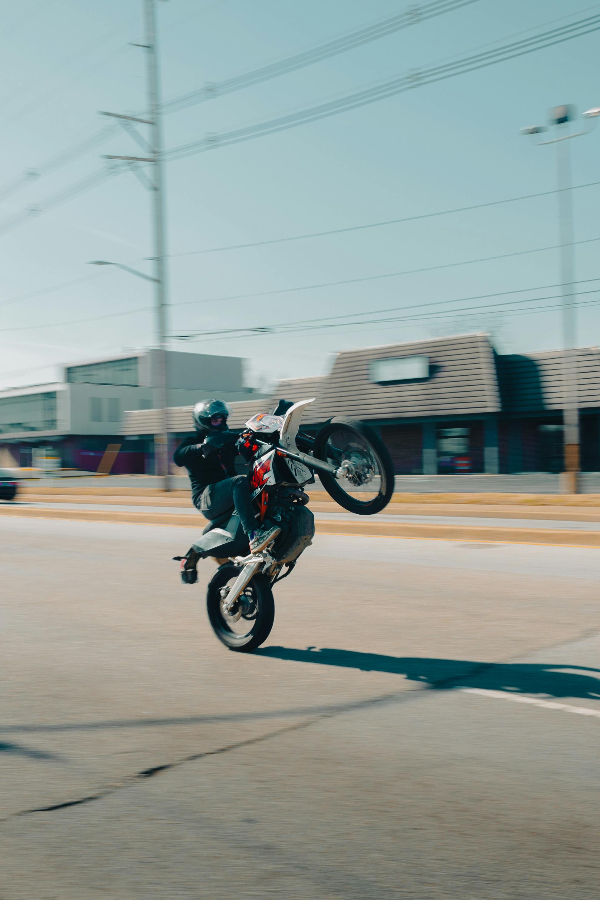 Dynamic Wheelie on City Street by Stunt Rider · Free Stock Photo