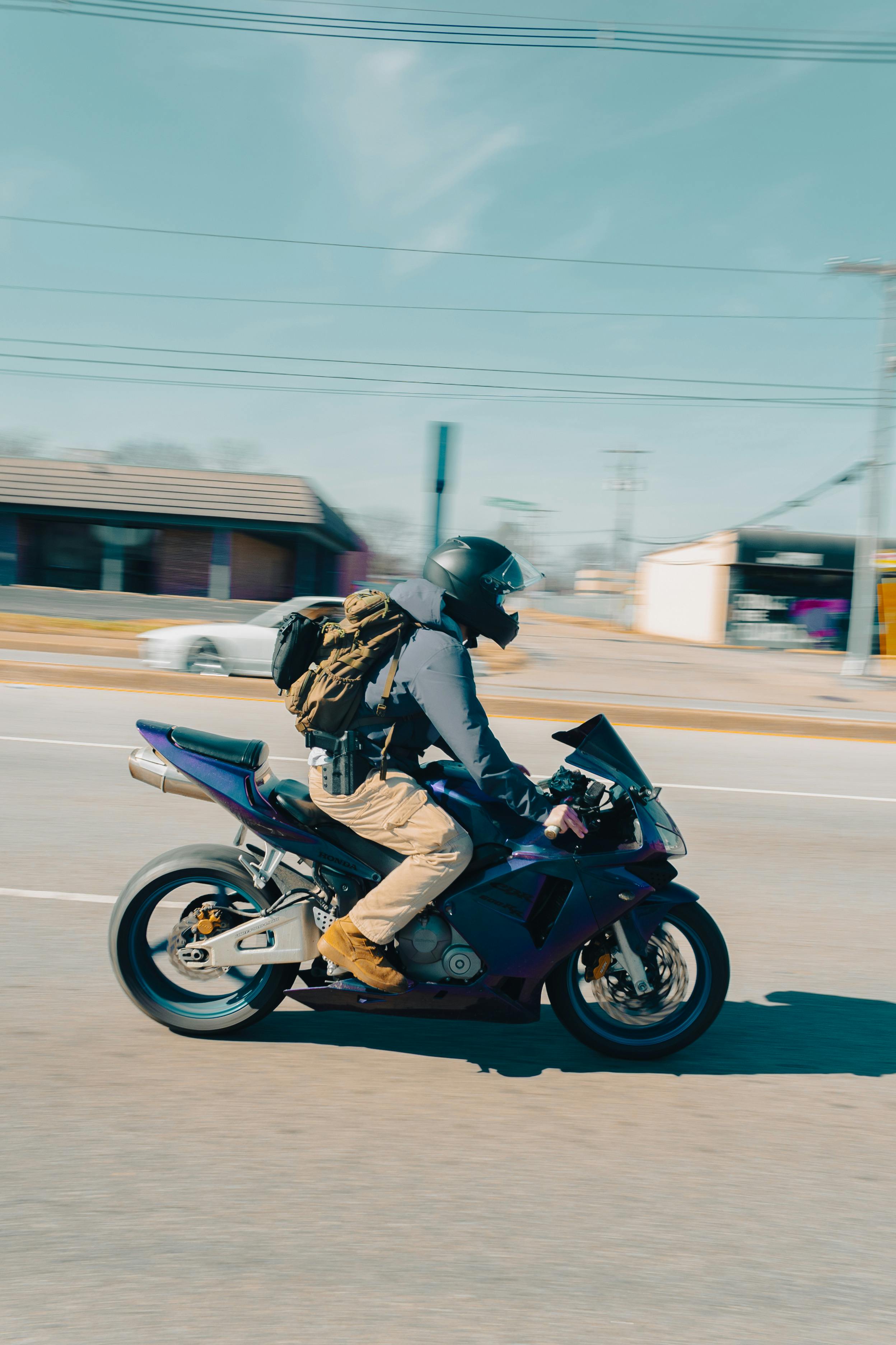 Photo of Person Riding Motorcycle on Road Between Trees · Free Stock Photo