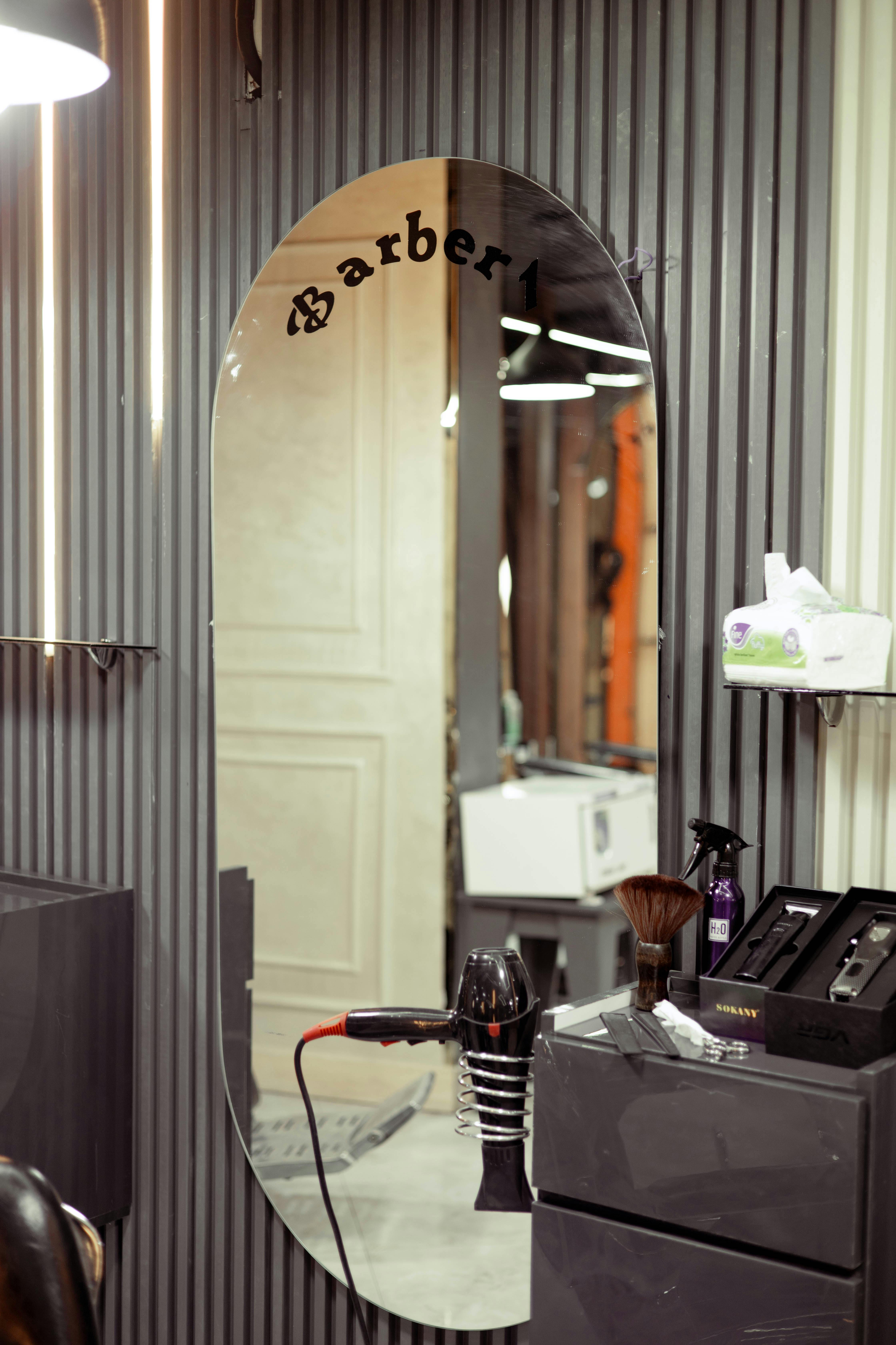Modern Barber Shop Interior with Mirror Reflection · Free Stock Photo