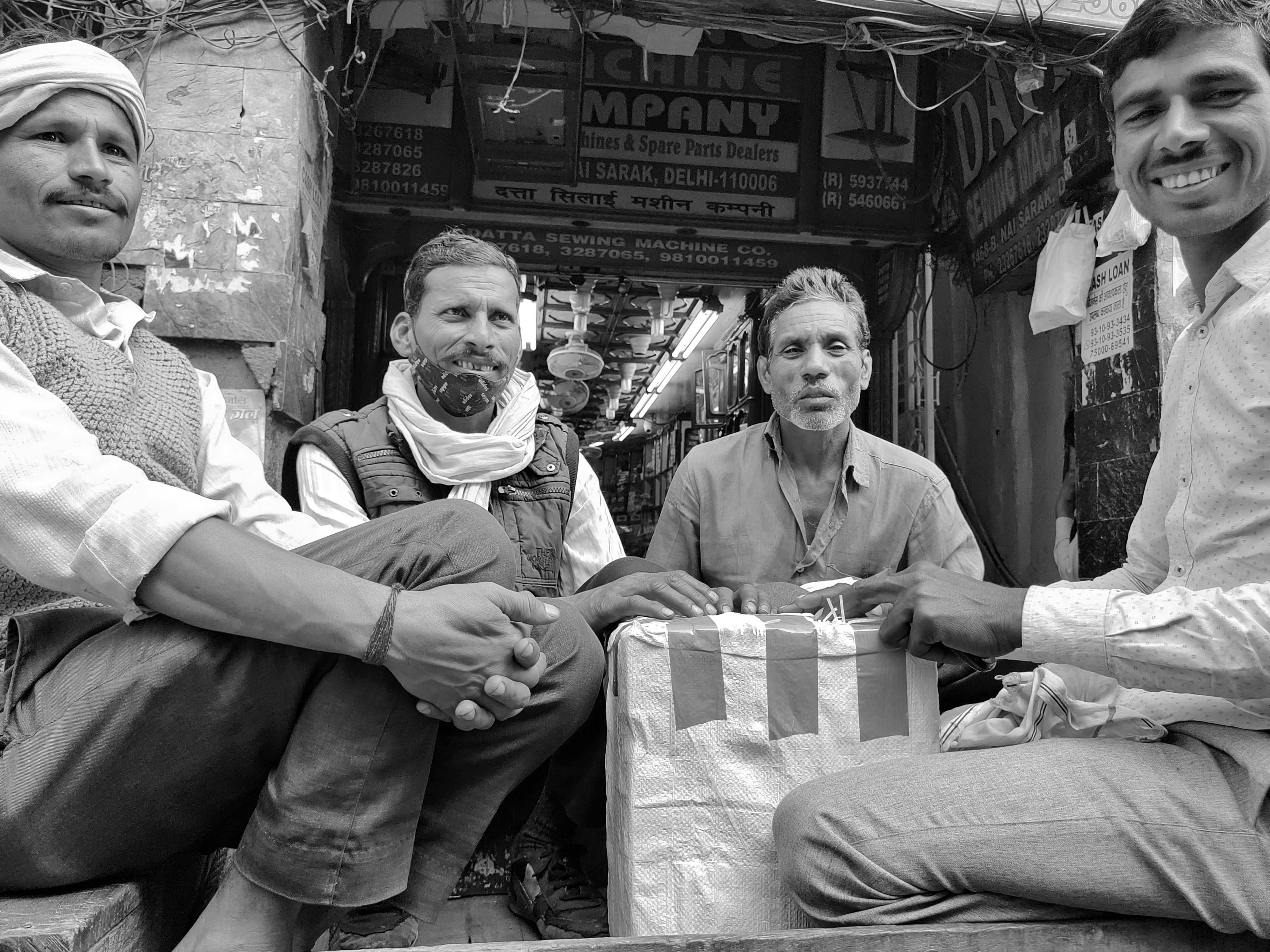 Group of Men Smiling in Front of a Shop · Free Stock Photo
