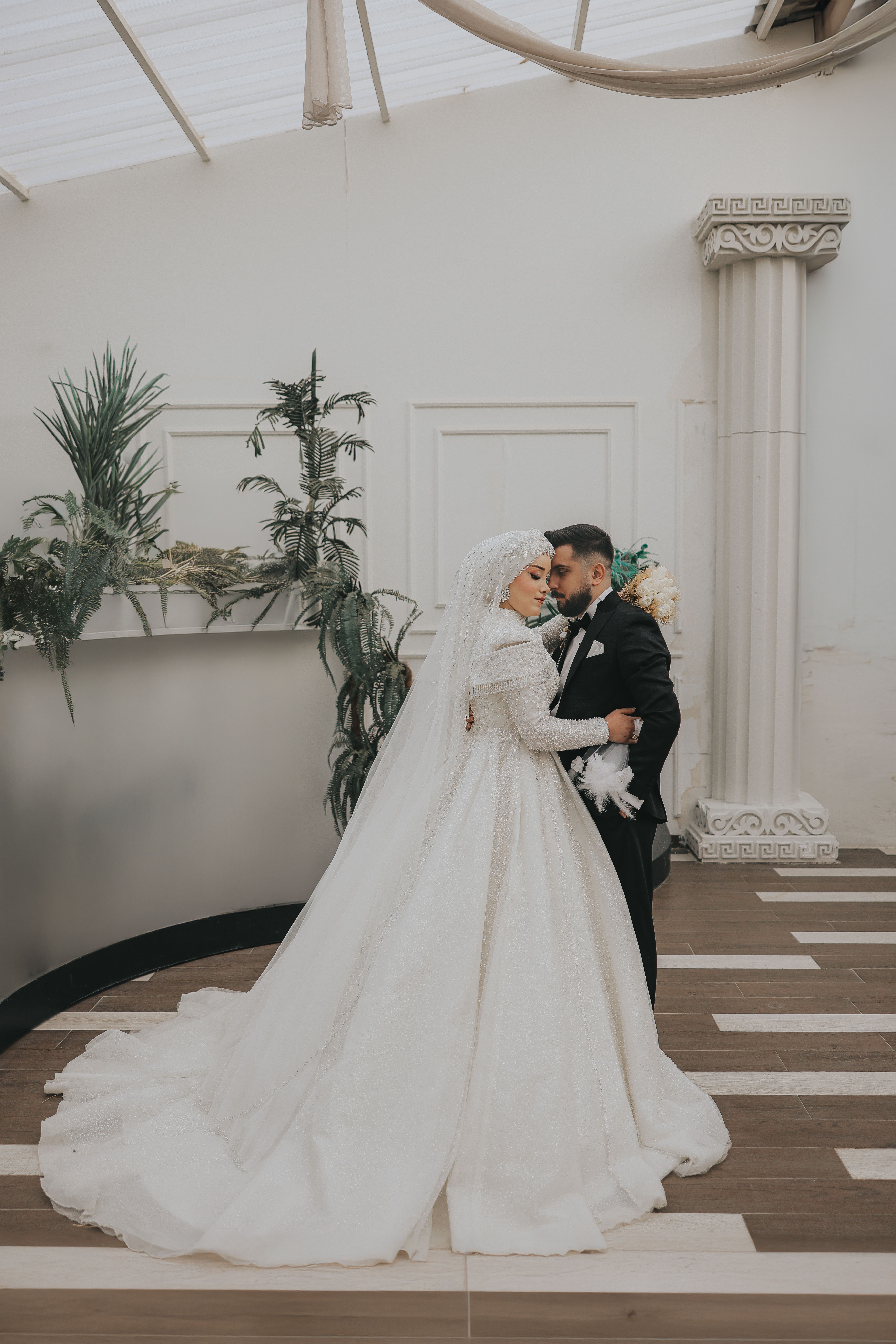 Elegant Indoor Wedding Embrace with Bride and Groom · Free Stock Photo