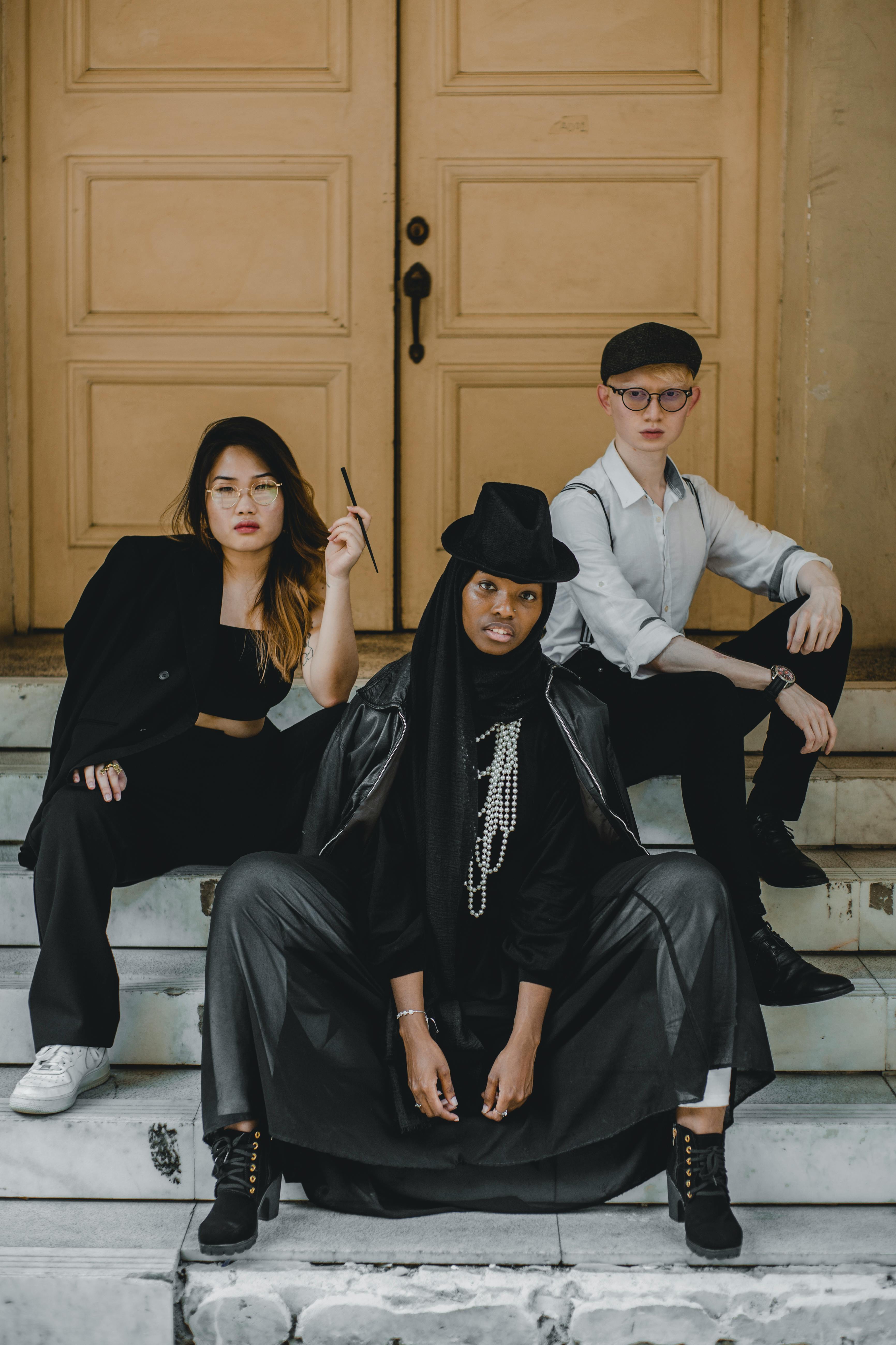 Diverse stylish people on steps · Free Stock Photo