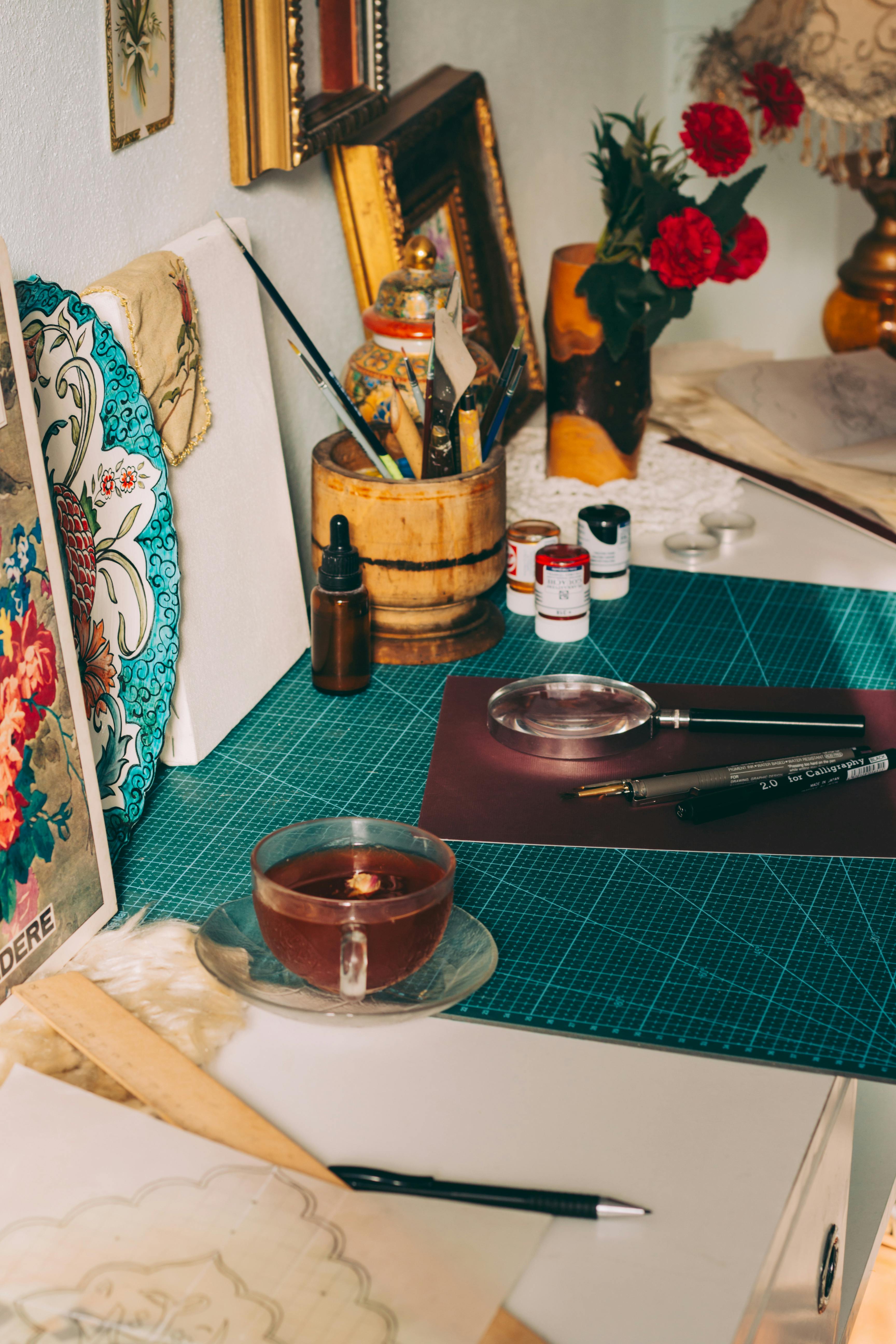 Artistic Workspace with Tools and Tea · Free Stock Photo