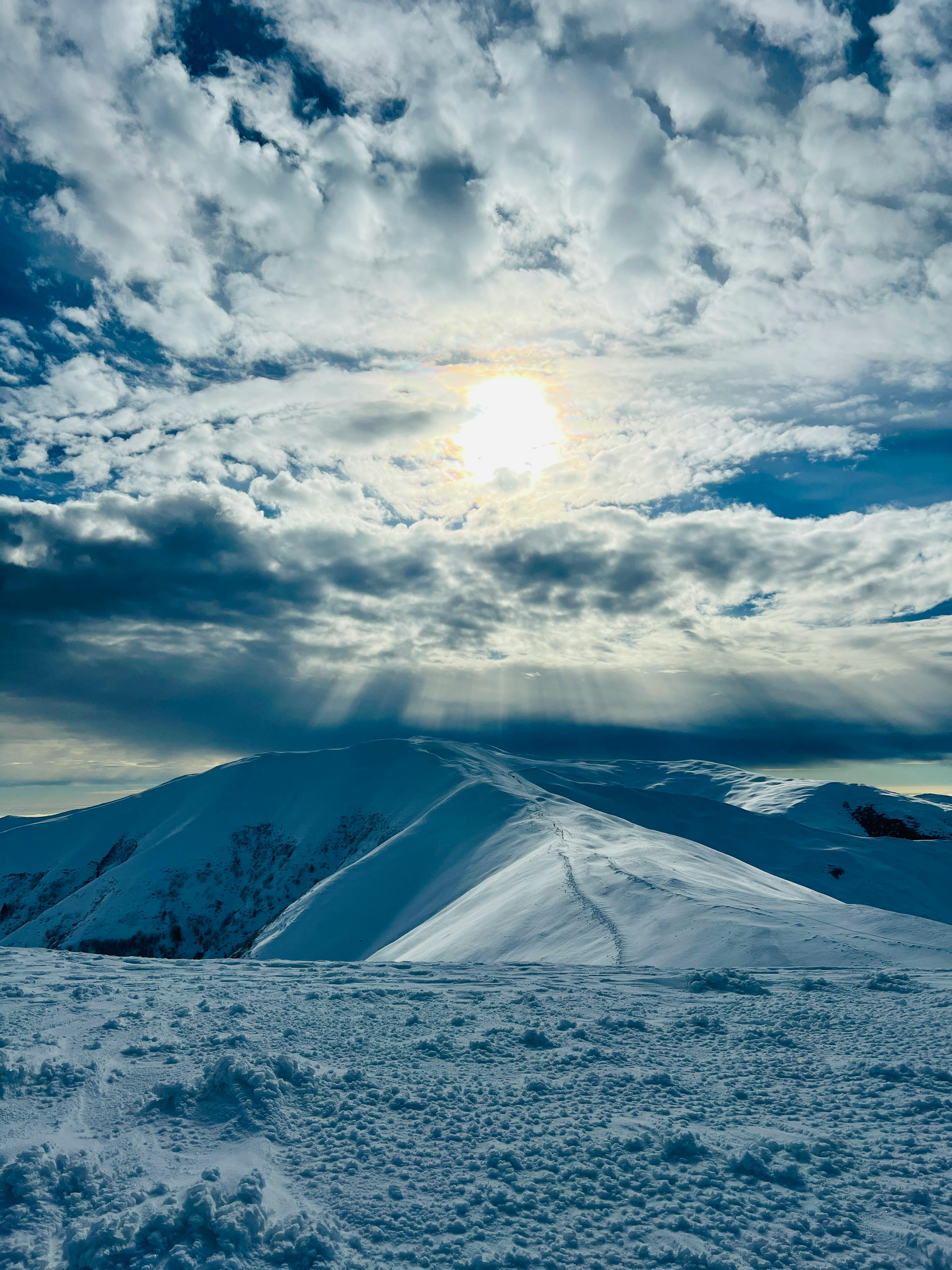 Sunlit Snowy Mountain Peaks in Winter · Free Stock Photo