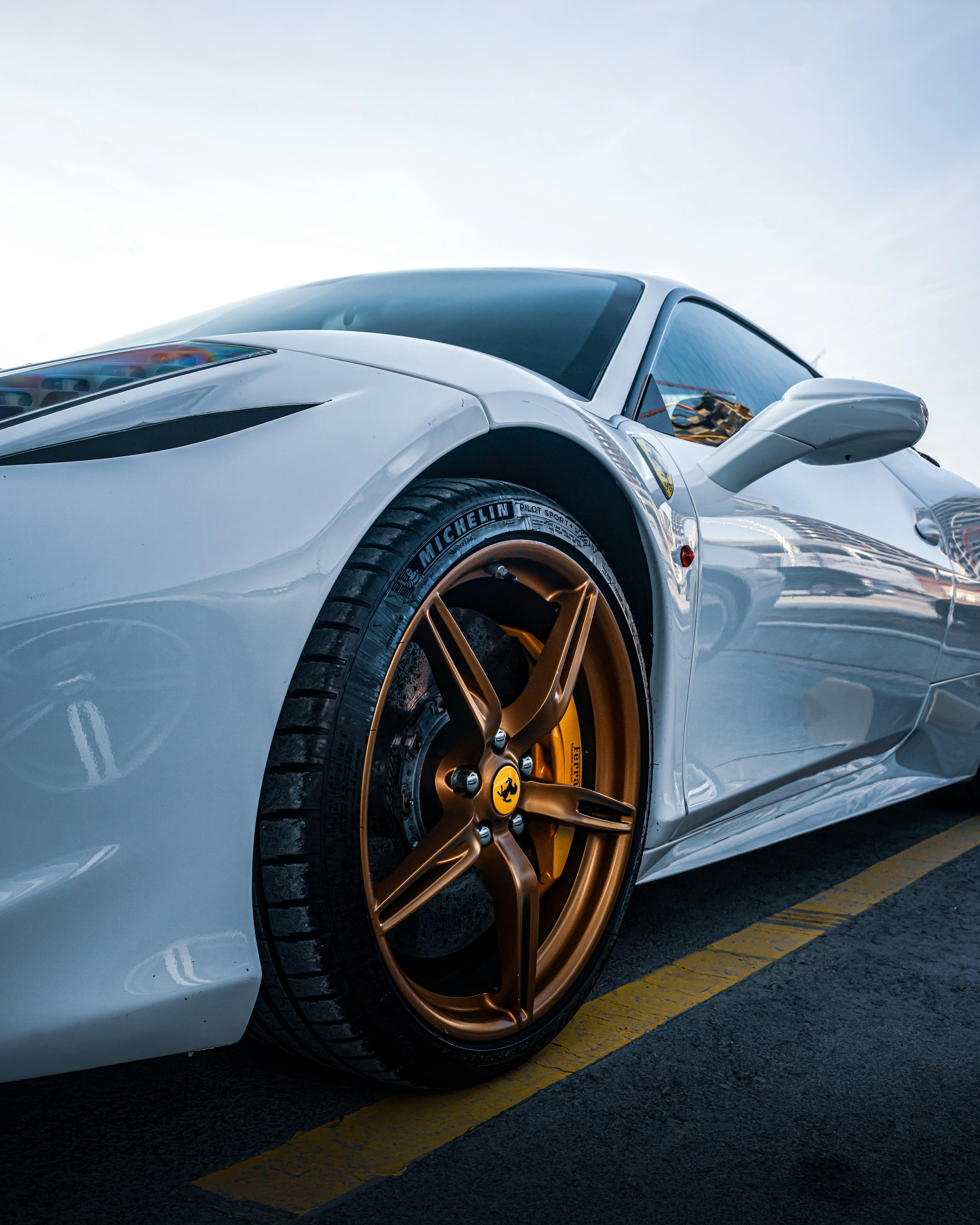 Sleek White Sports Car with Bronze Alloy Wheels · Free Stock Photo