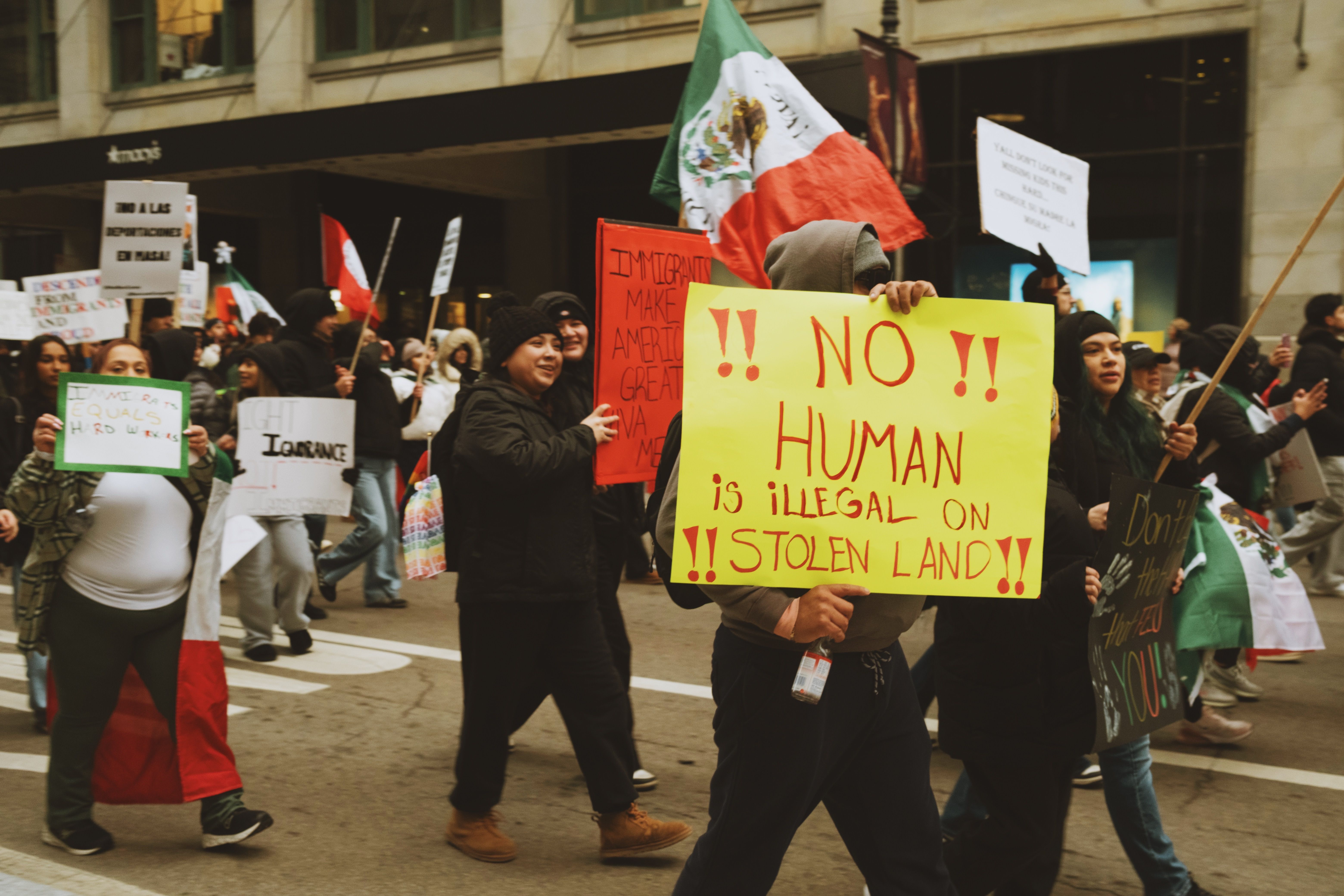 Immigration Protest with Bold Signage in Urban Setting · Free Stock Photo