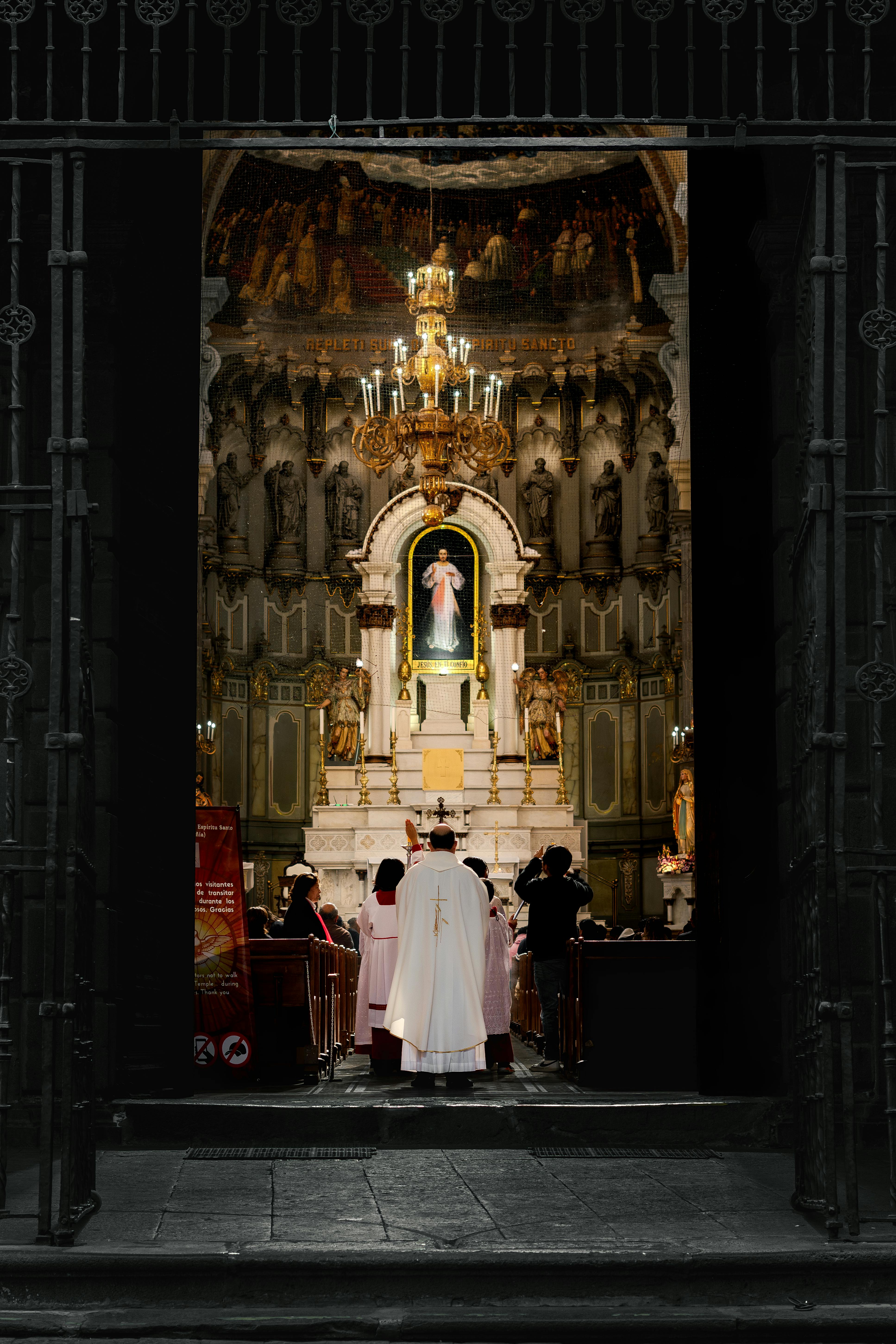 Ornate Church Interior with Priest and Altar · Free Stock Photo