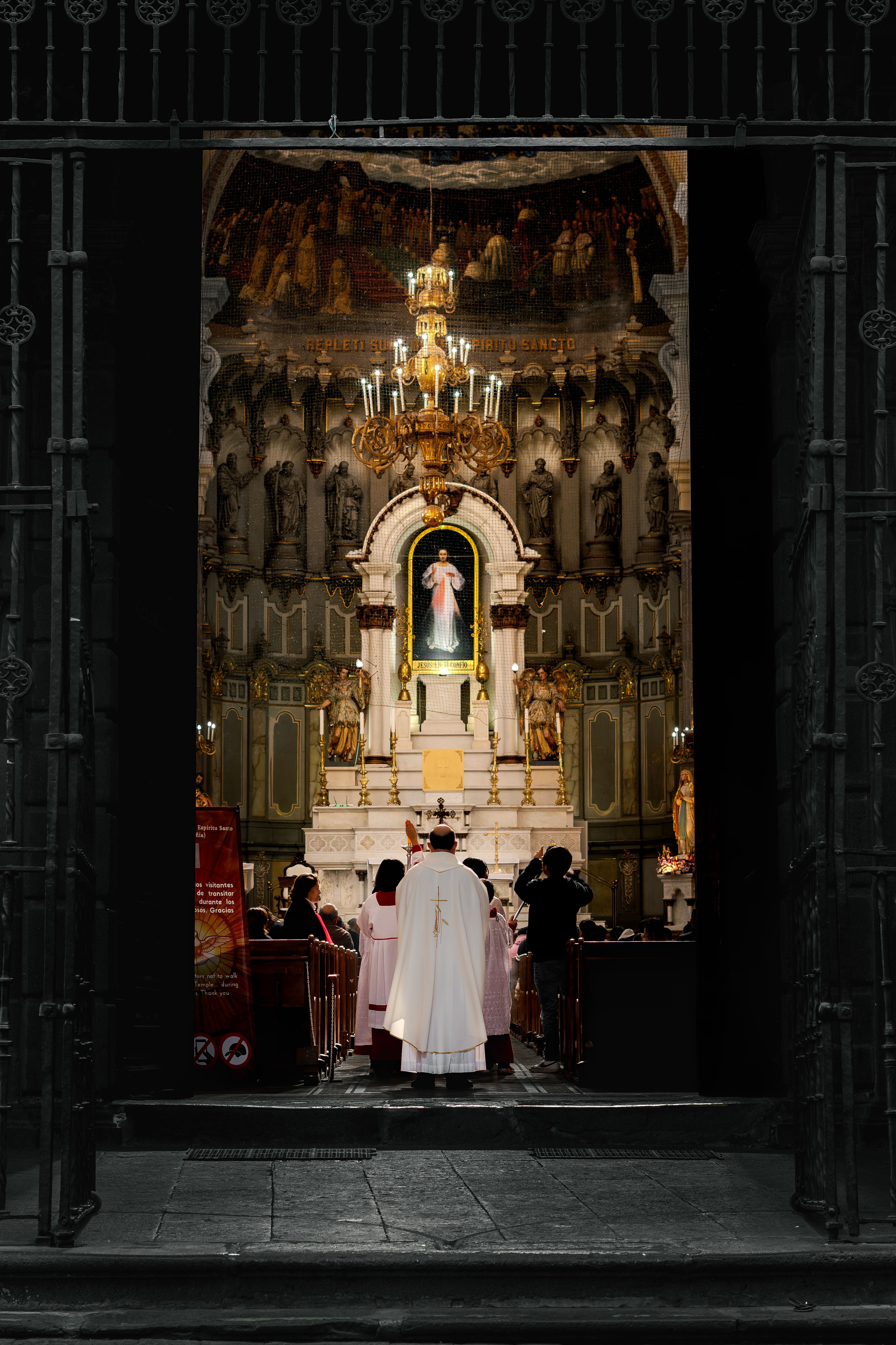 Ornate Church Interior with Priest and Altar · Free Stock Photo
