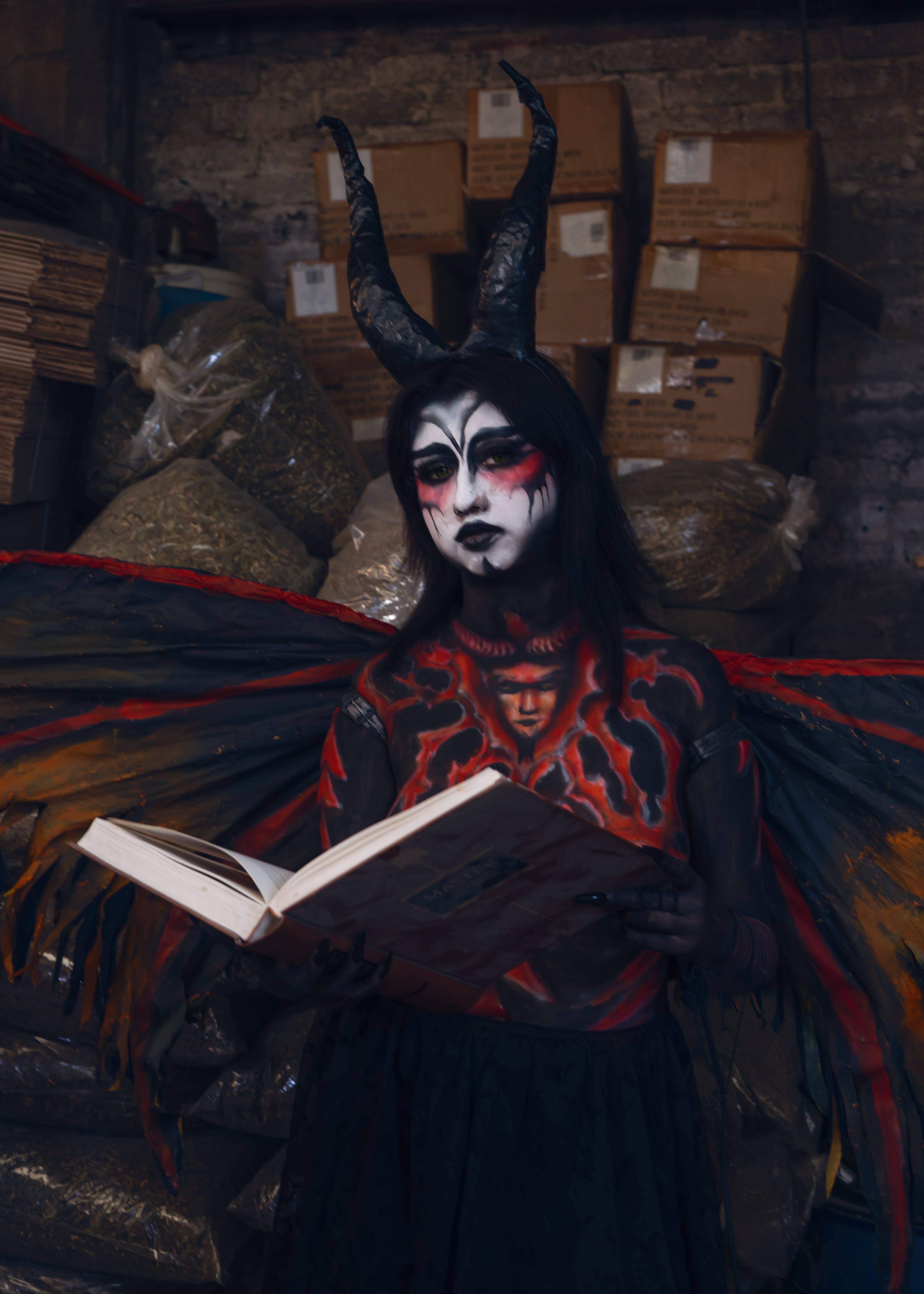 Demonic Costume with Book in Dark Setting · Free Stock Photo