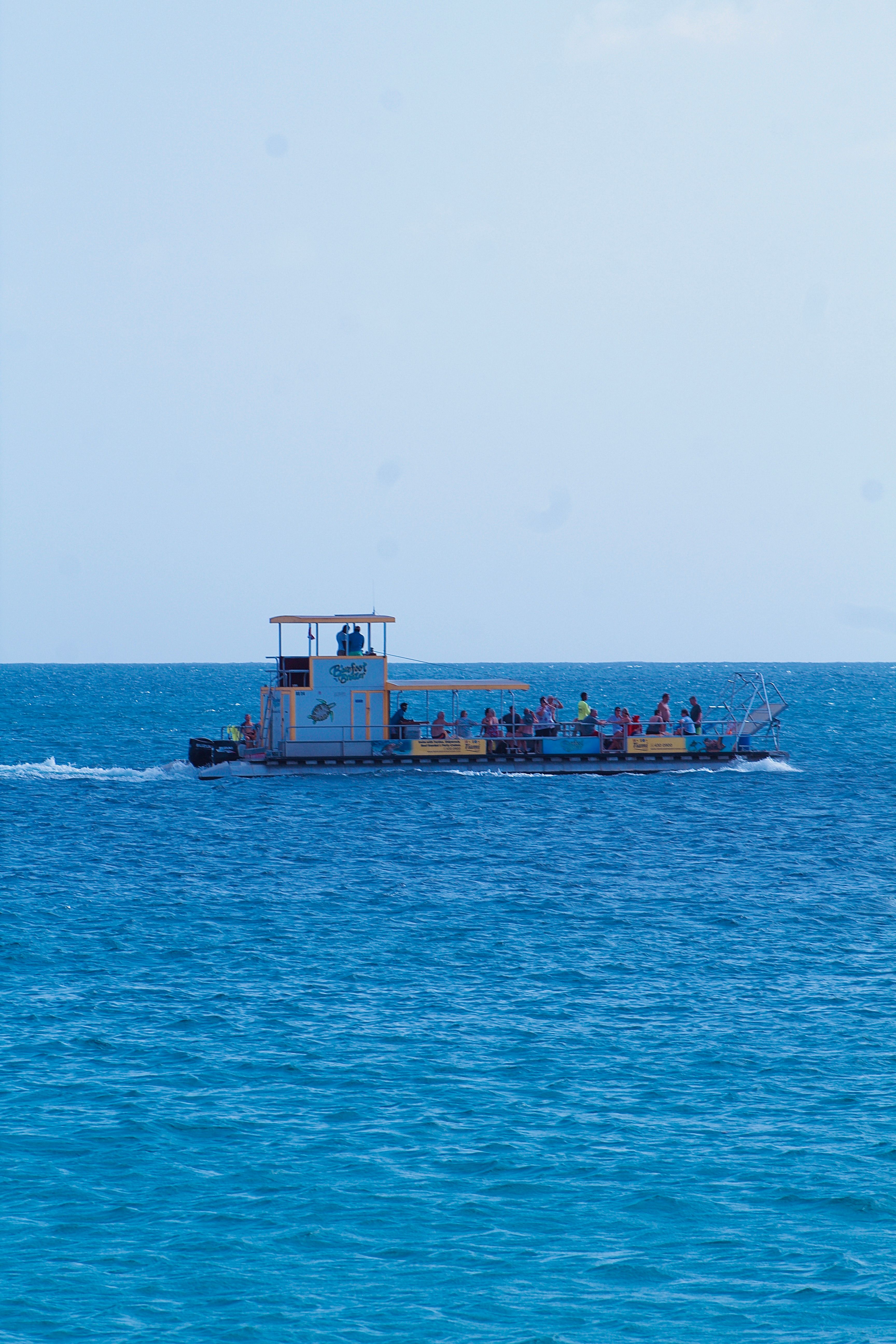 Colorful Ferry Boat on Pristine Blue Ocean · Free Stock Photo