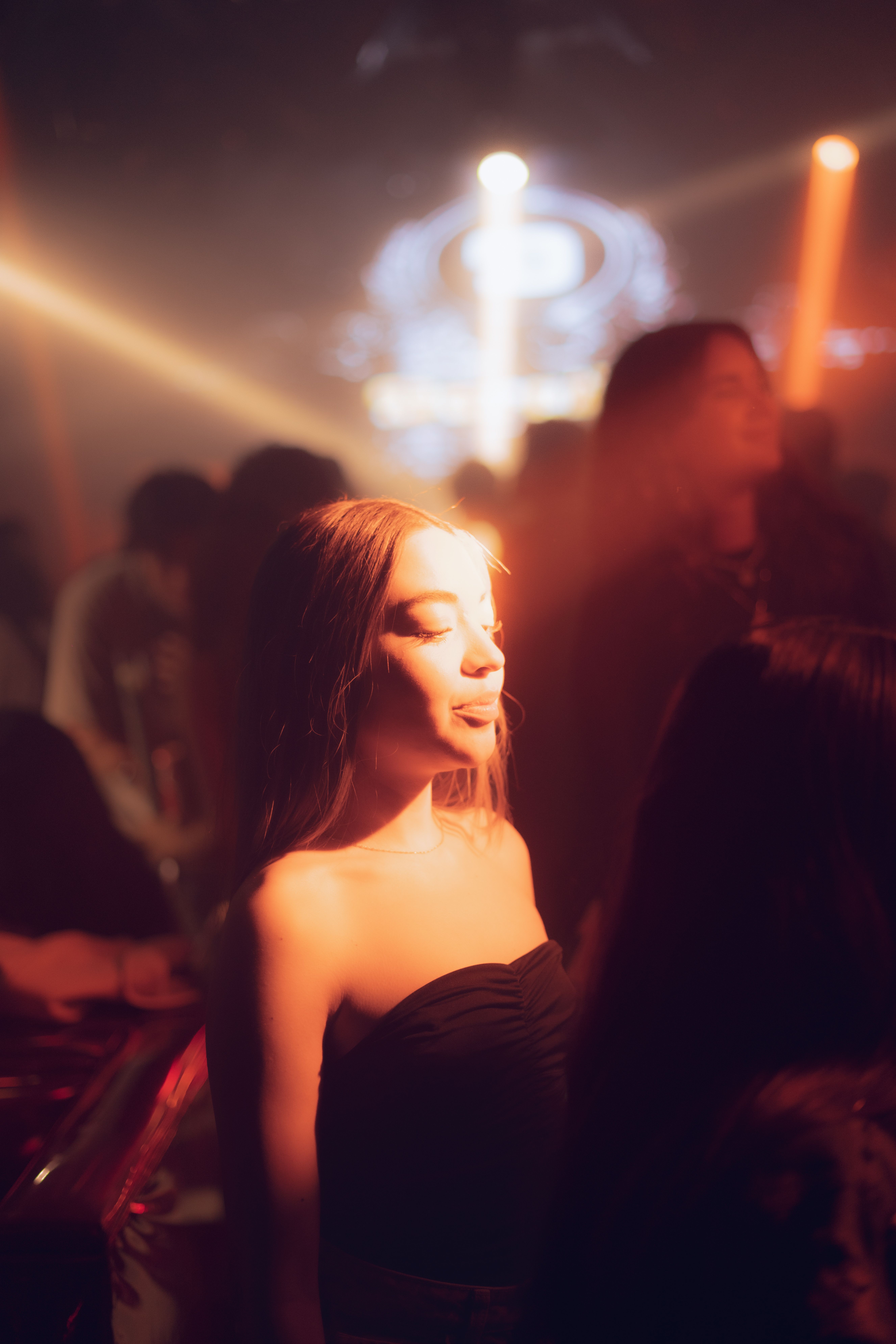 Young Woman Partying in a Nightclub Spotlight · Free Stock Photo